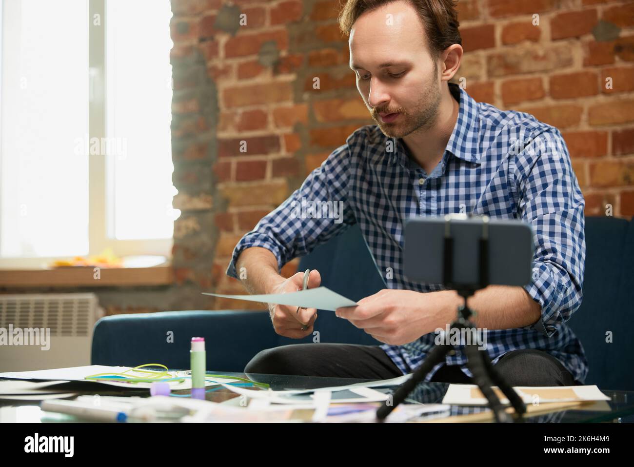 Young happy man holds a master class on appliques, quilling and ...