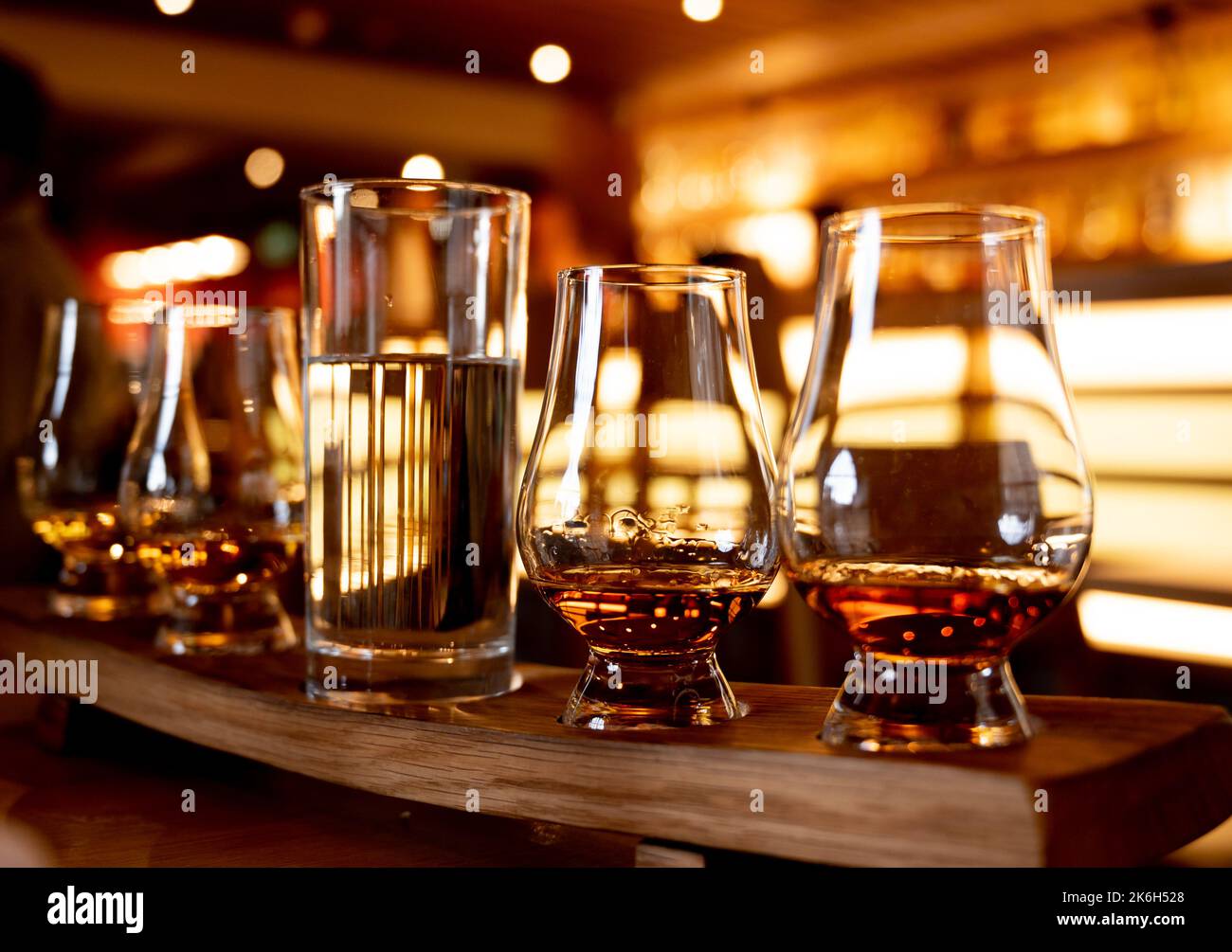 Flight of single malt scotch whisky in glasses served in bar in ...