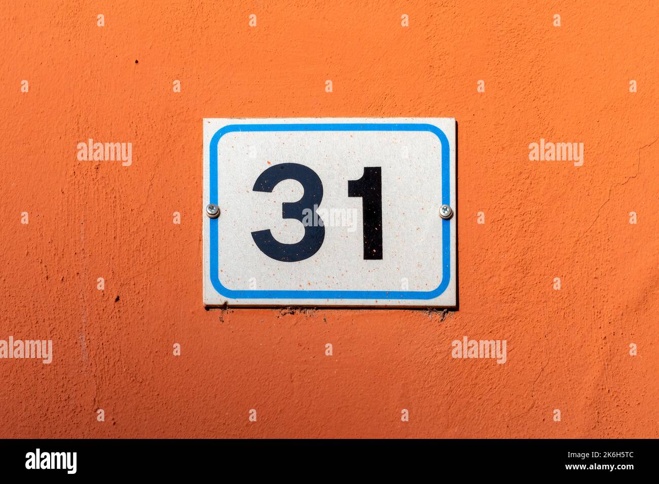 Number thirty one on enamel plate on painted orange wall Stock Photo ...