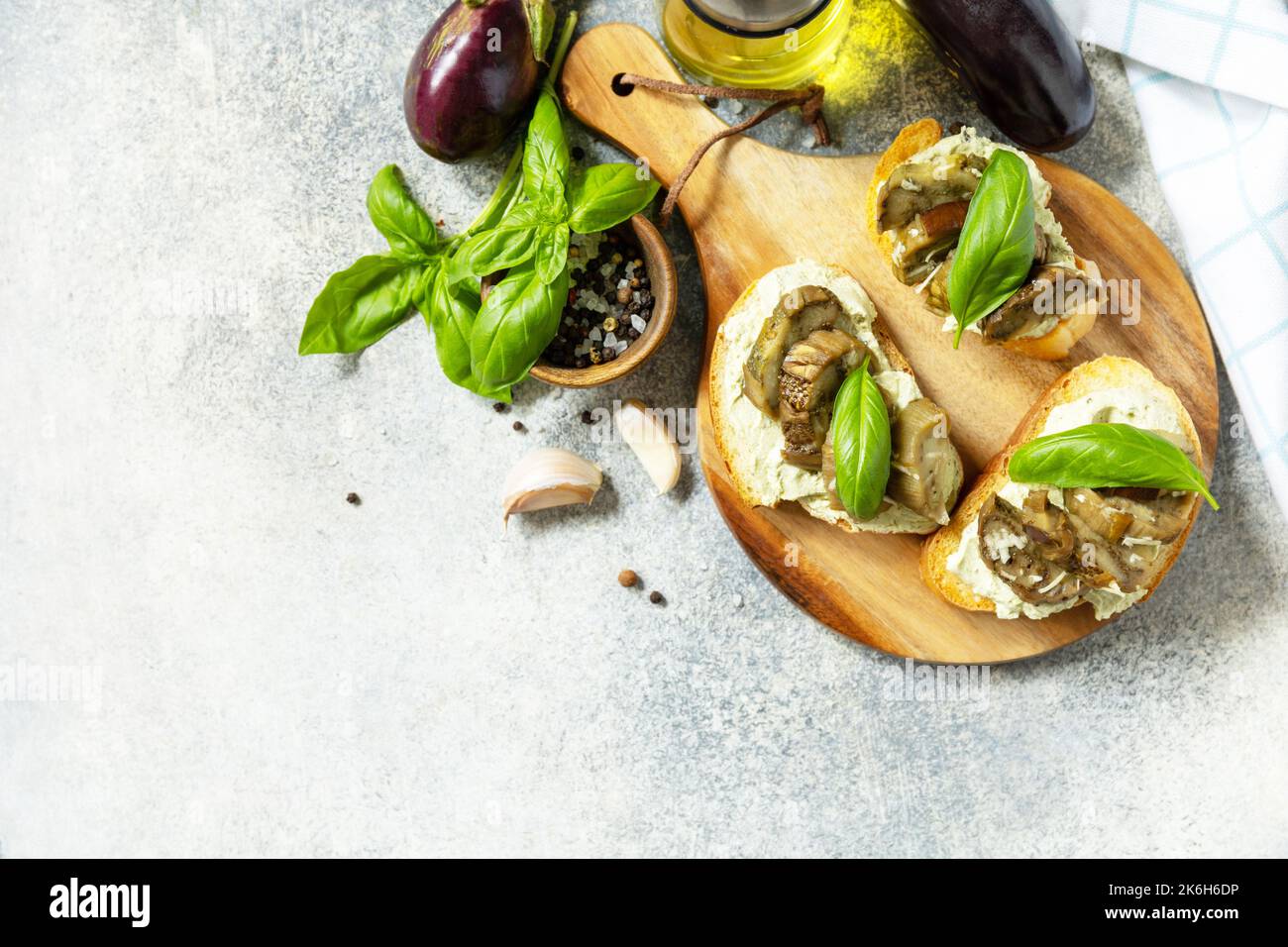 Open sandwiches set with grill aubergine and cream cheese on a stone ...