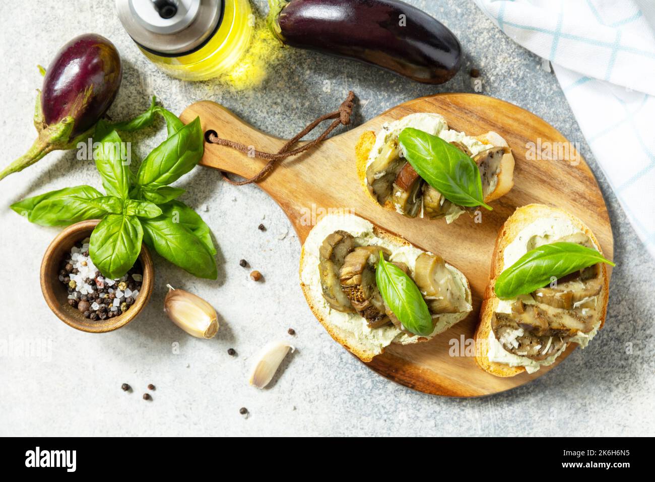 Open sandwiches set with grill aubergine and cream cheese on a stone ...