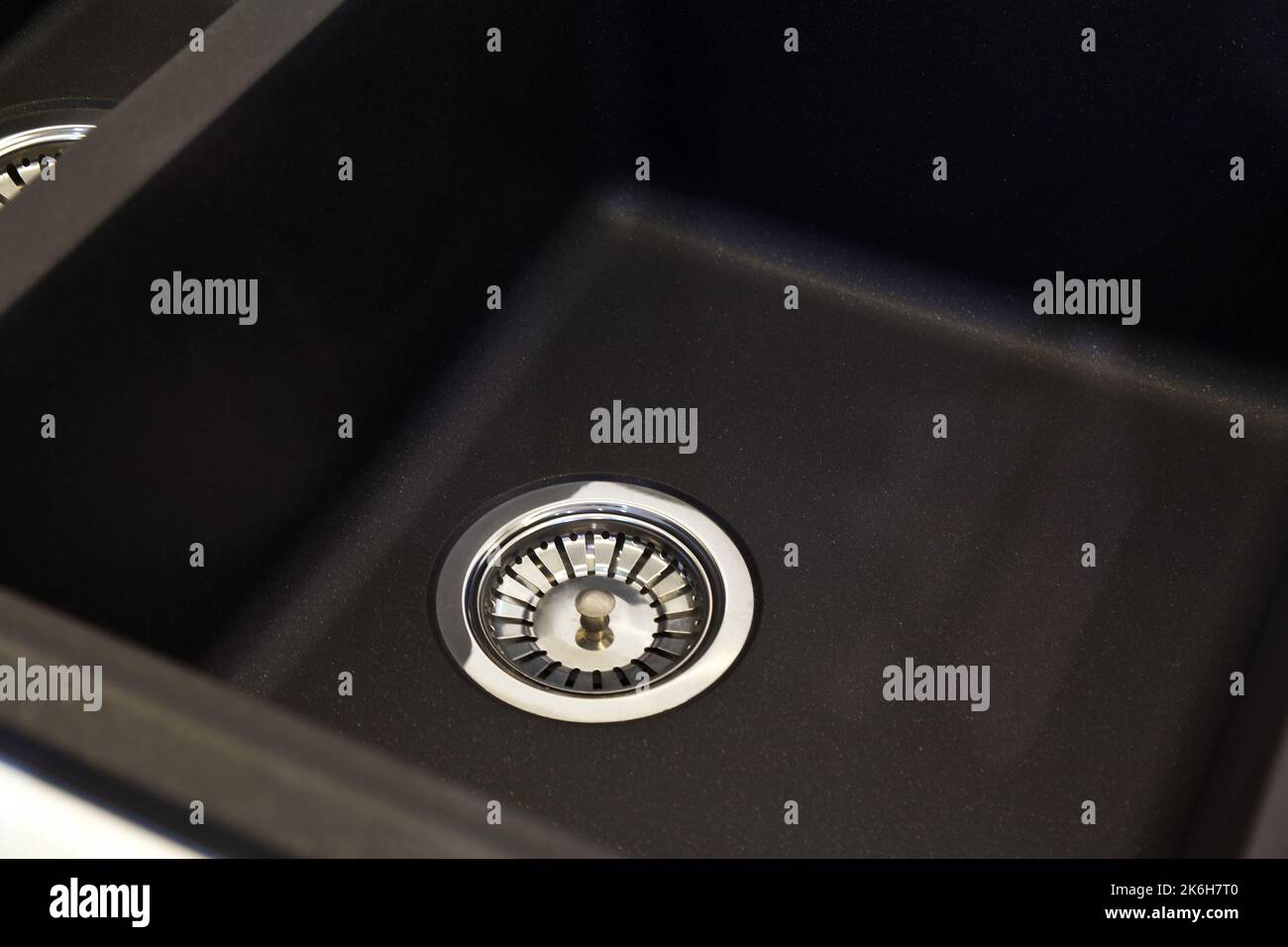 Black granite kitchen sink and stainless steel water drain, modern and ...