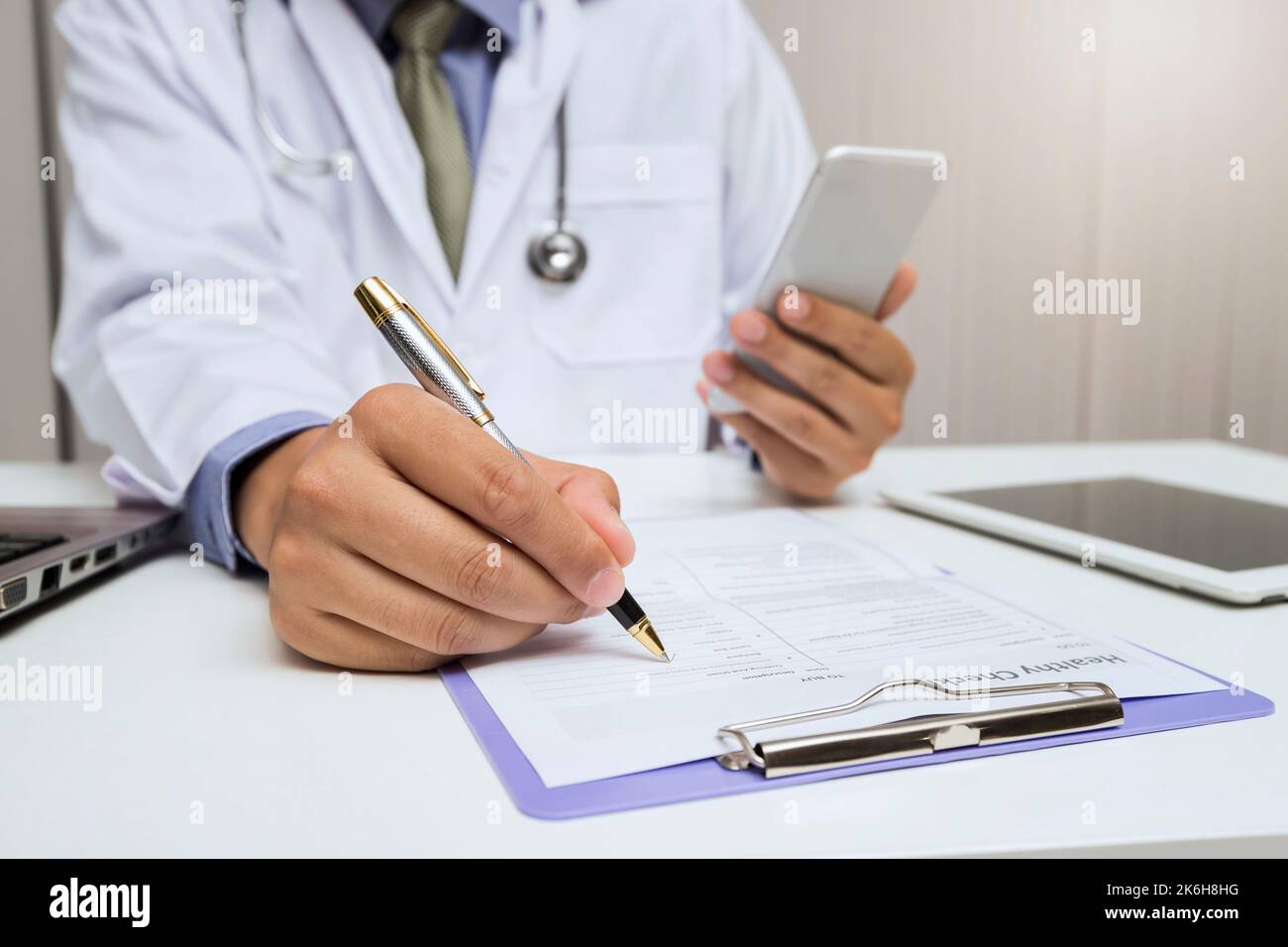 Medic write on medical chart from modern smart phone, Medical network ...