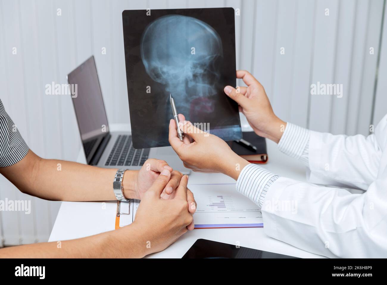 Medical and health care concept. Doctor explaining x-ray results to ...