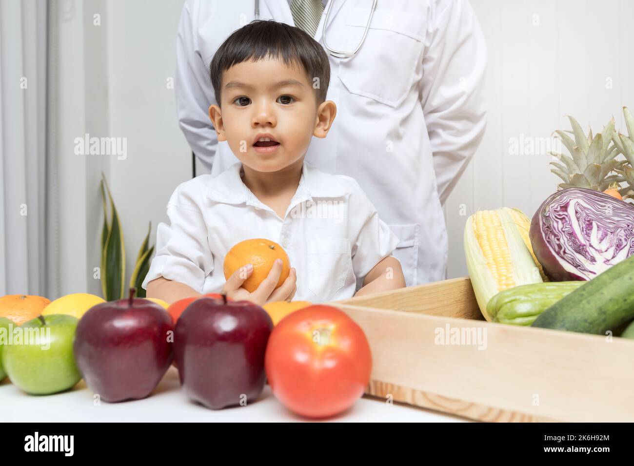 A boy and doctor happy to have healthy food. Kid learning about ...
