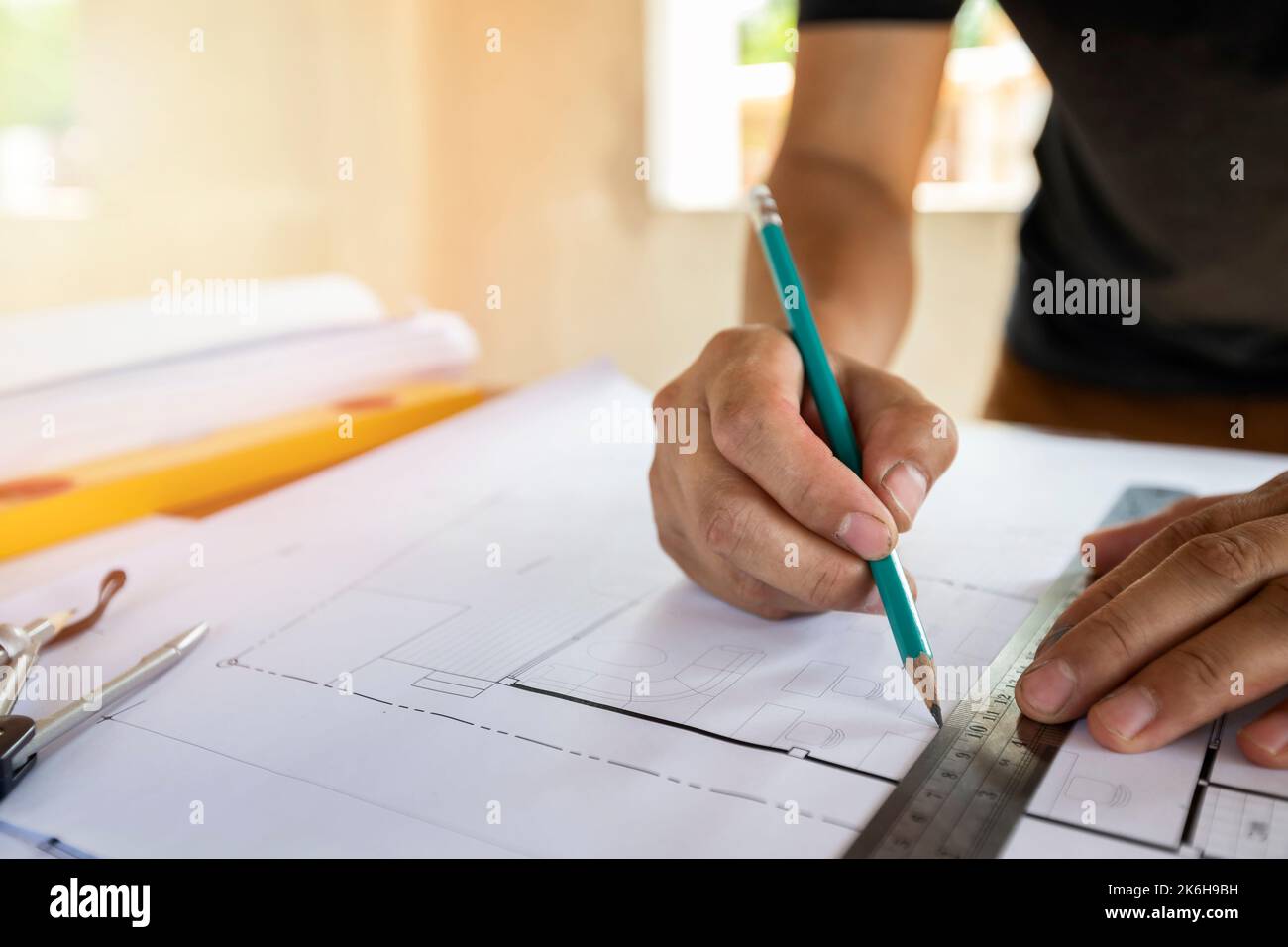 Architect measuring scale on blueprint in construction site Stock Photo ...