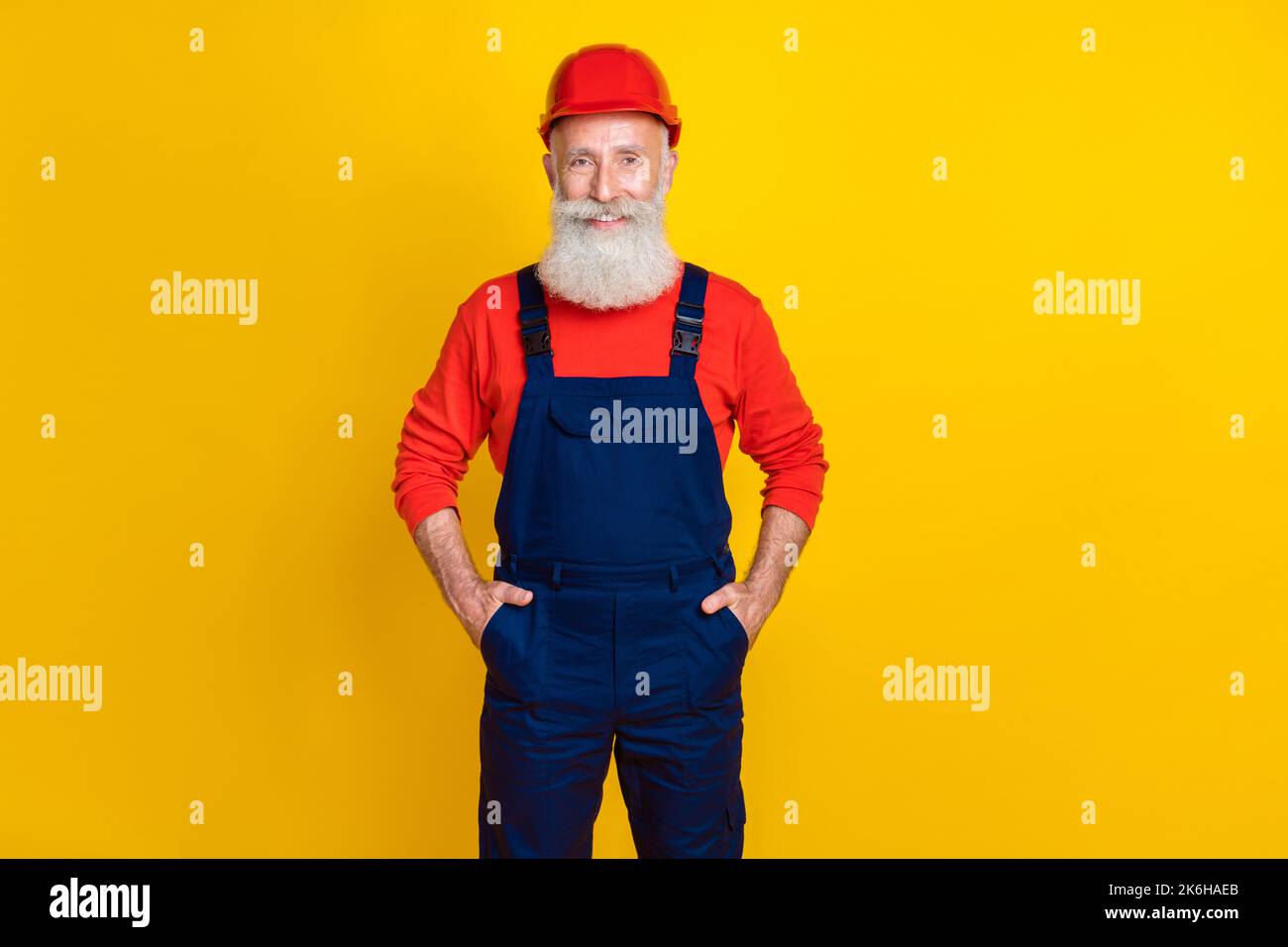 Photo of good mood cheerful senior guy dressed uniform overall red ...