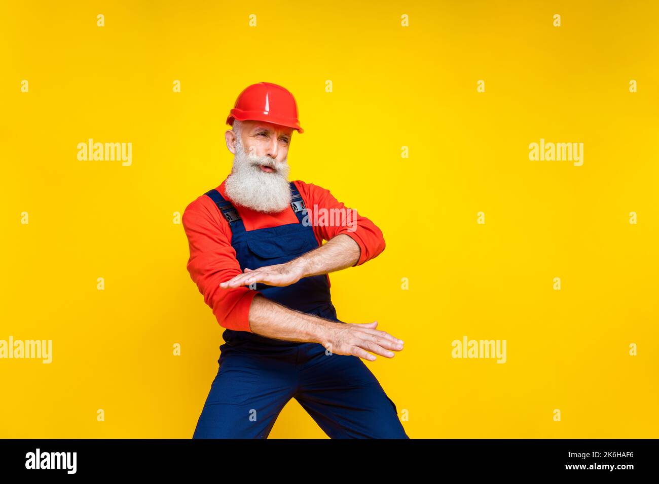 Full length photo of carefree senior engineer with white beard red ...