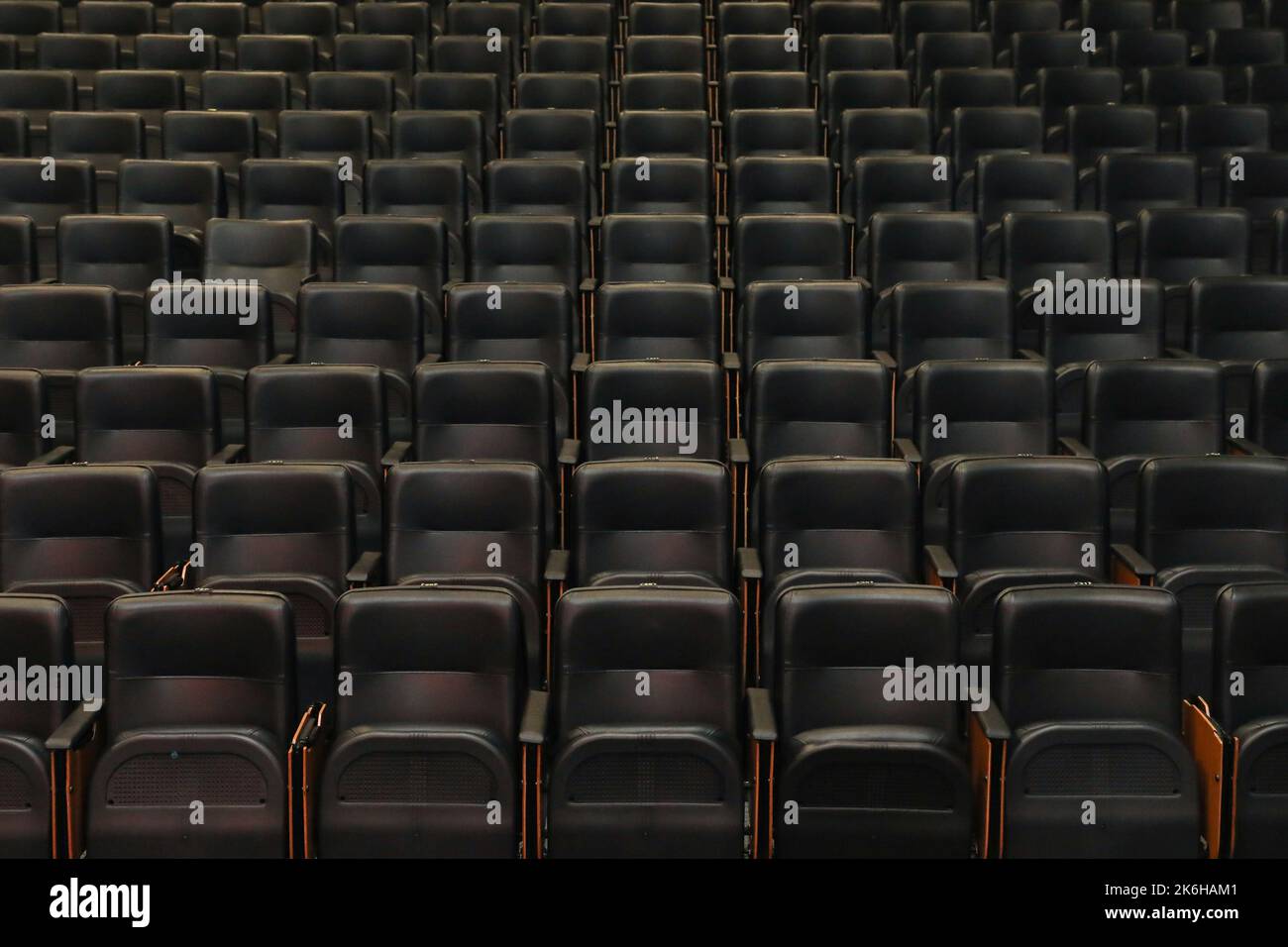 Theater auditorium with emphasis on the black chairs and wooden sides ...