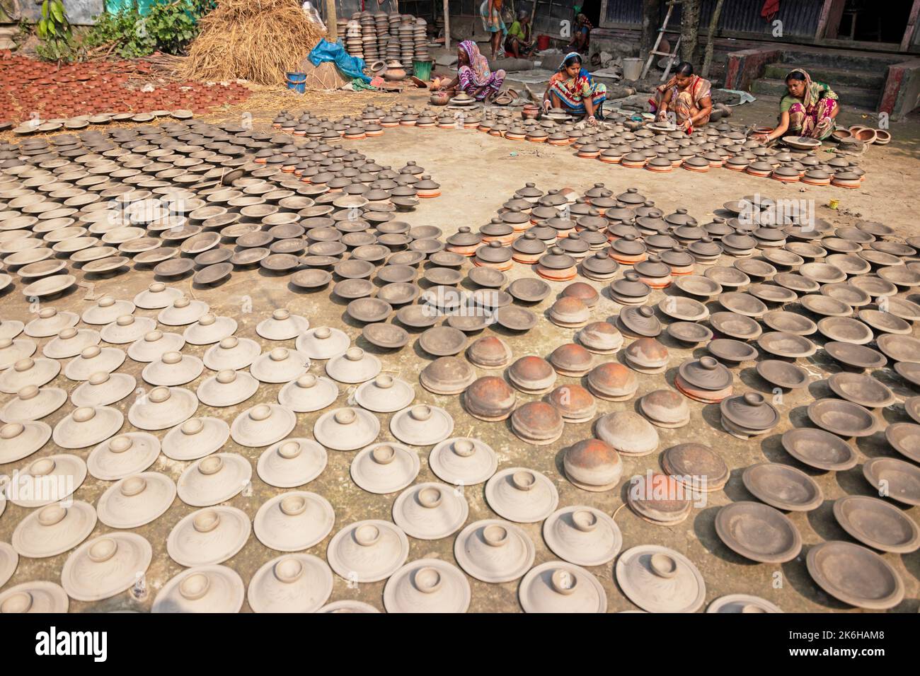 Workers make clay pots as a form of pottery business to sell at a ...