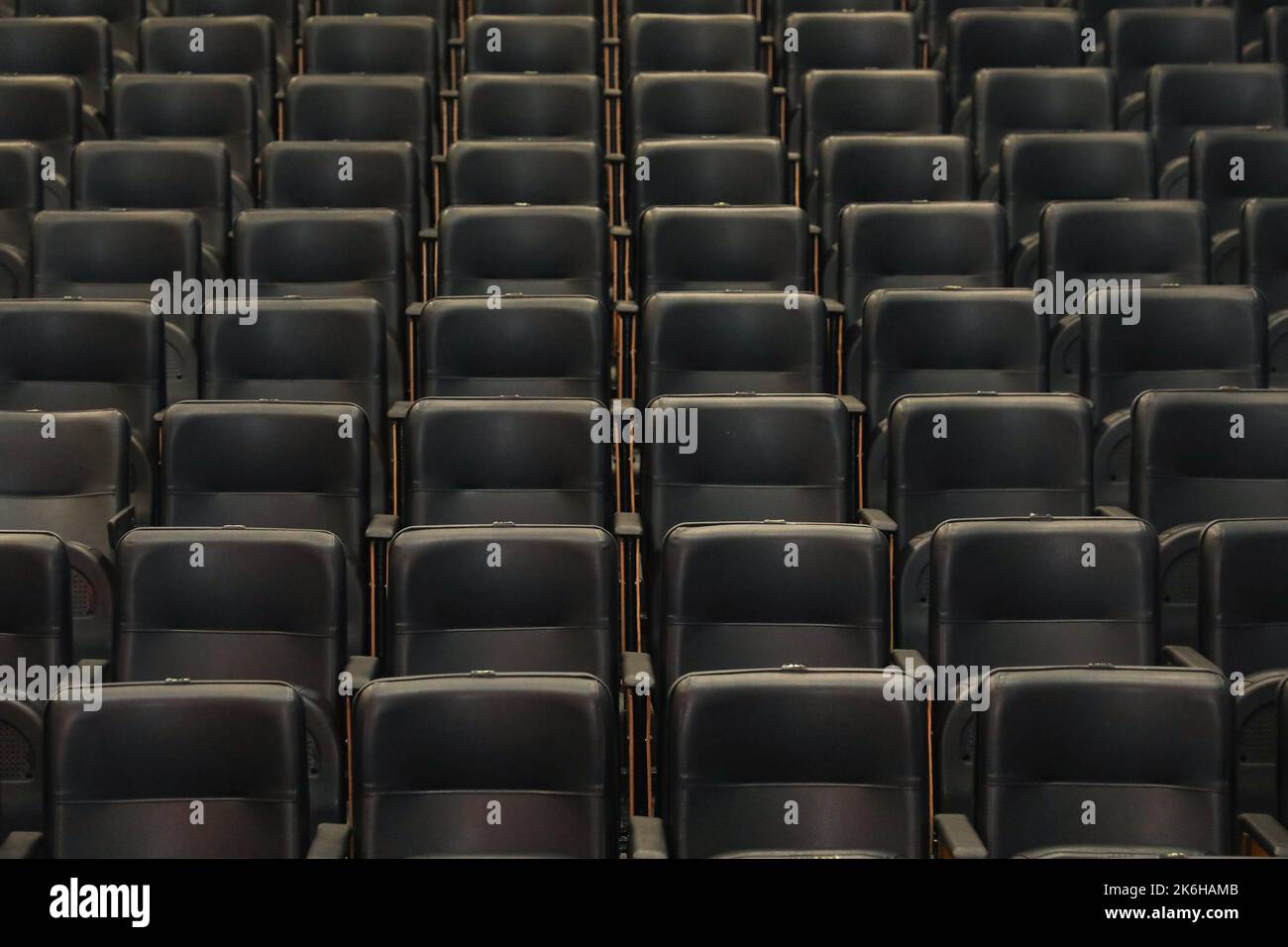 Theater auditorium with emphasis on the black chairs and wooden sides ...