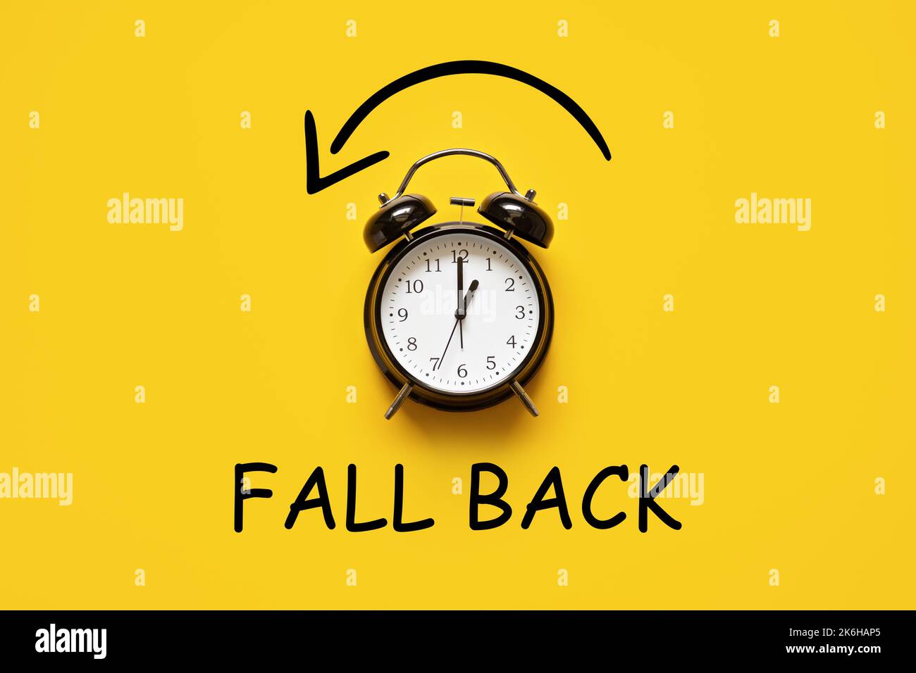 Daylight saving day. Fall Back. Black Alarm clock and autumn leaves and ...