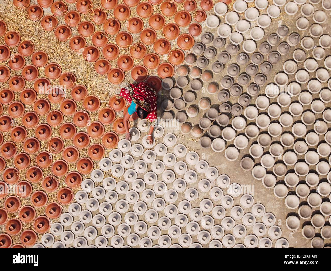 Workers make clay pots as a form of pottery business to sell at a ...