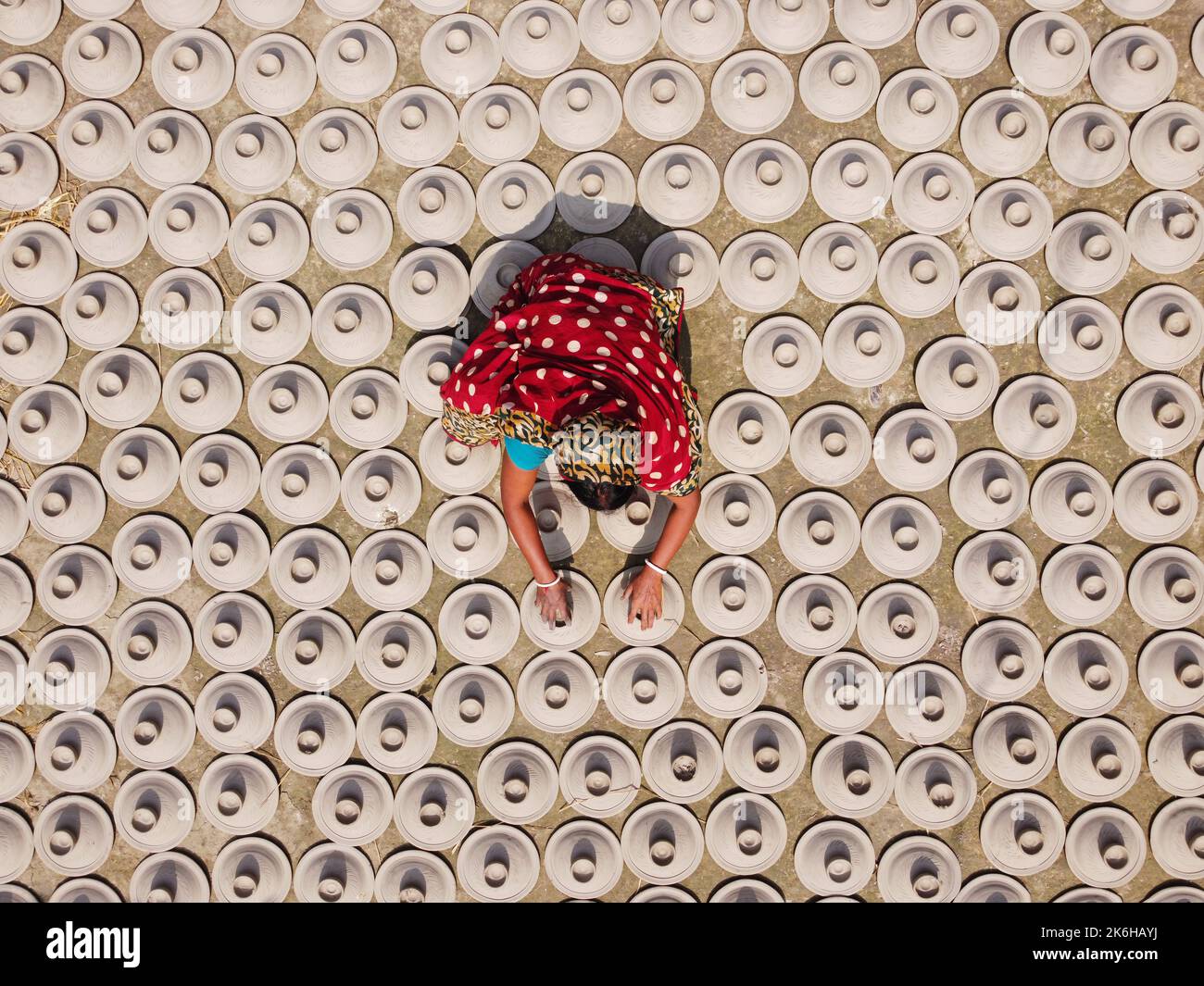 Workers make clay pots as a form of pottery business to sell at a ...