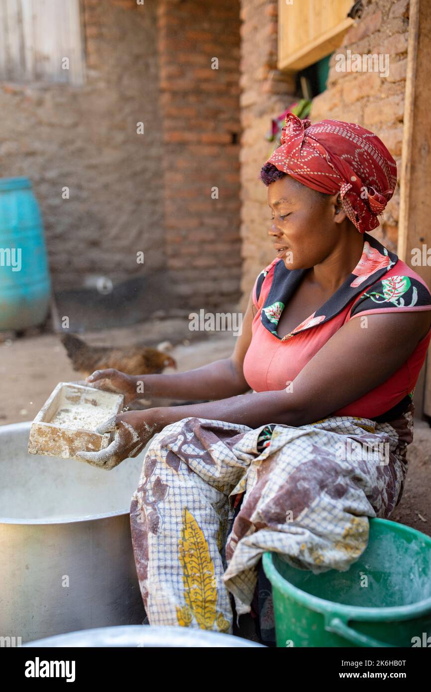 Woman preparing cassava flour hi-res stock photography and images - Alamy