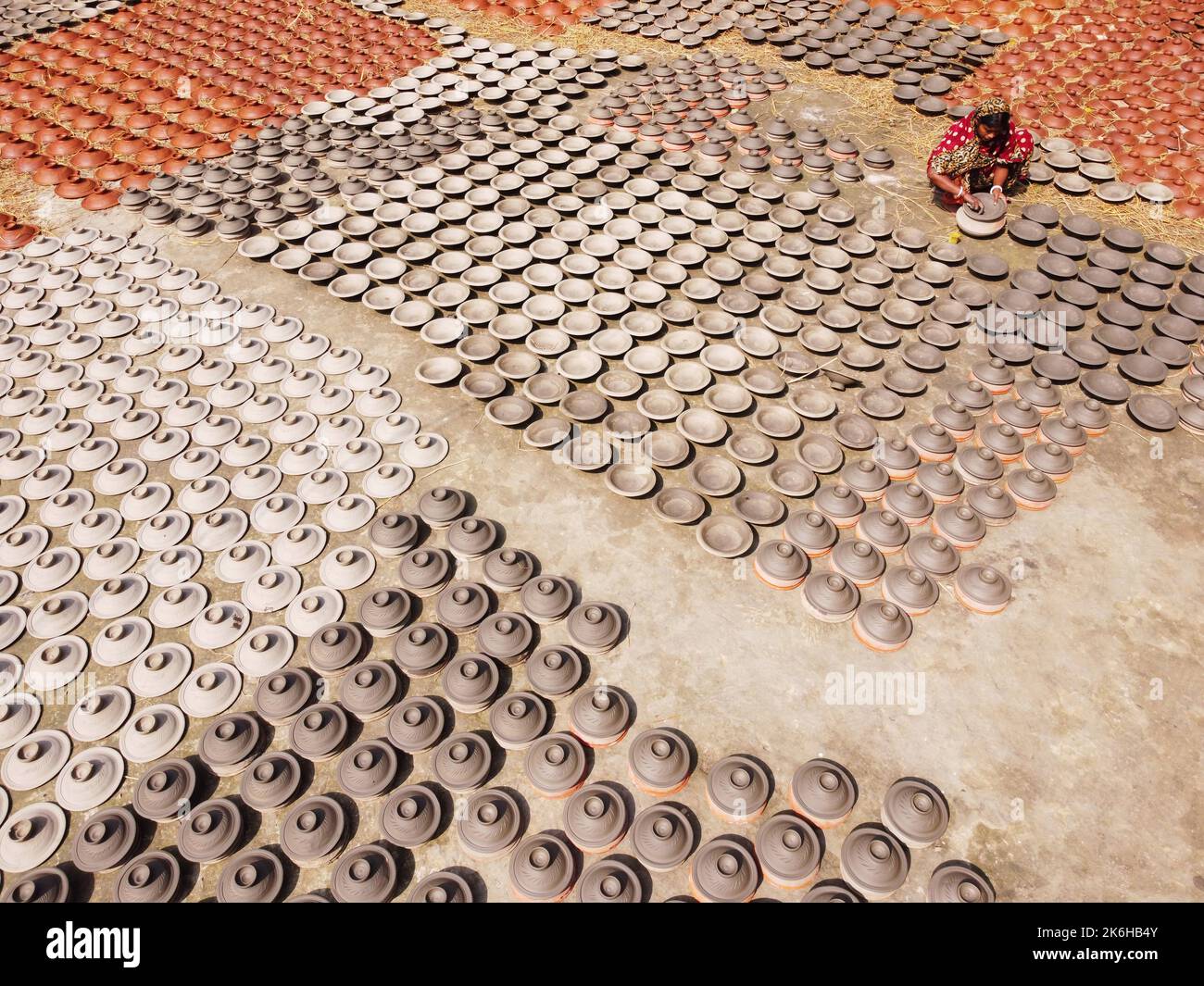 Workers make clay pots as a form of pottery business to sell at a ...