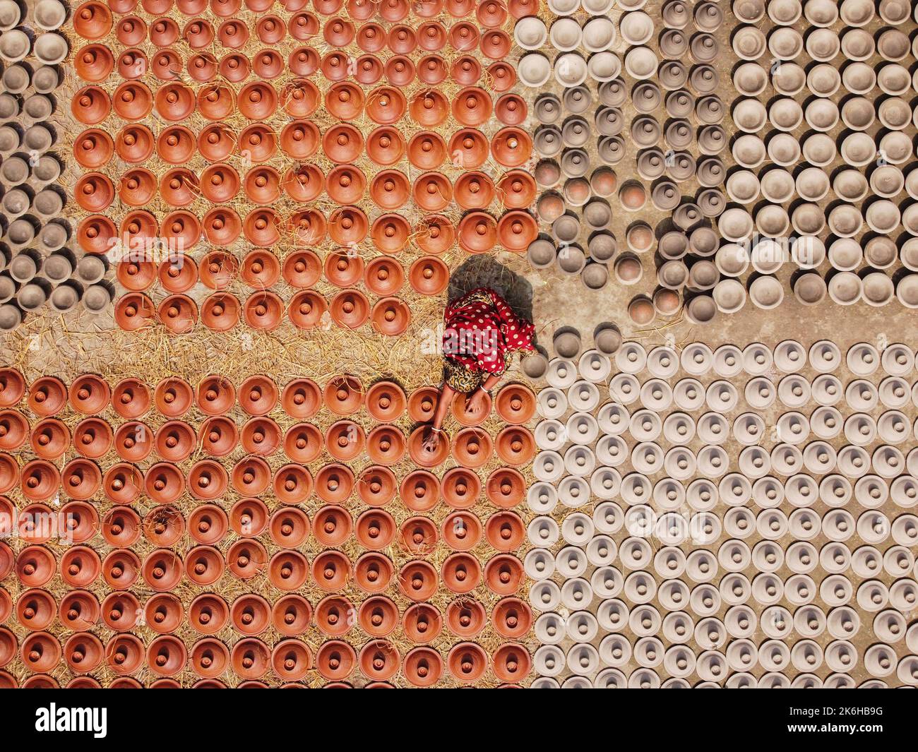Workers make clay pots as a form of pottery business to sell at a ...