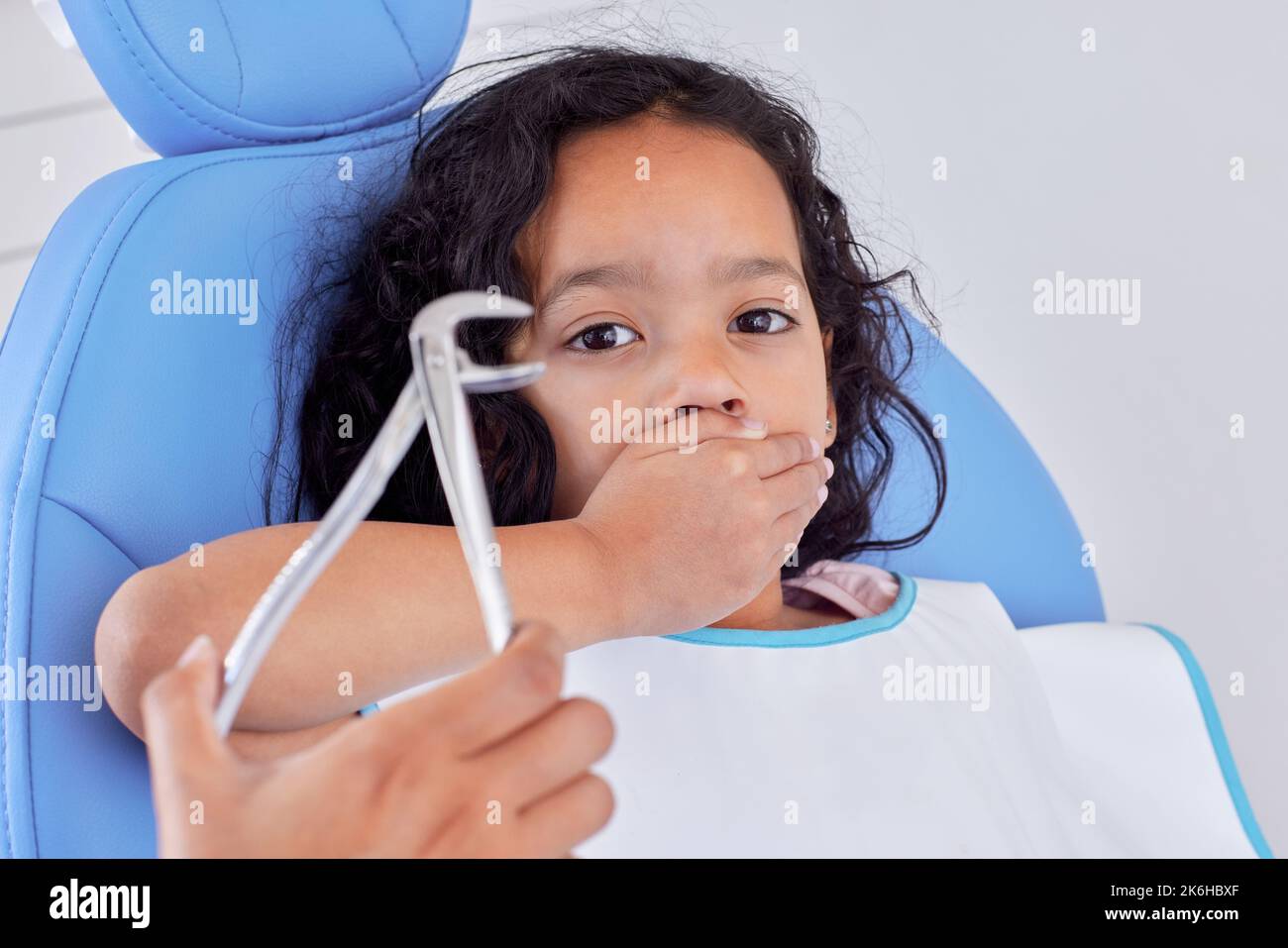 Teeth are always in style. a young girl looking scared while having ...