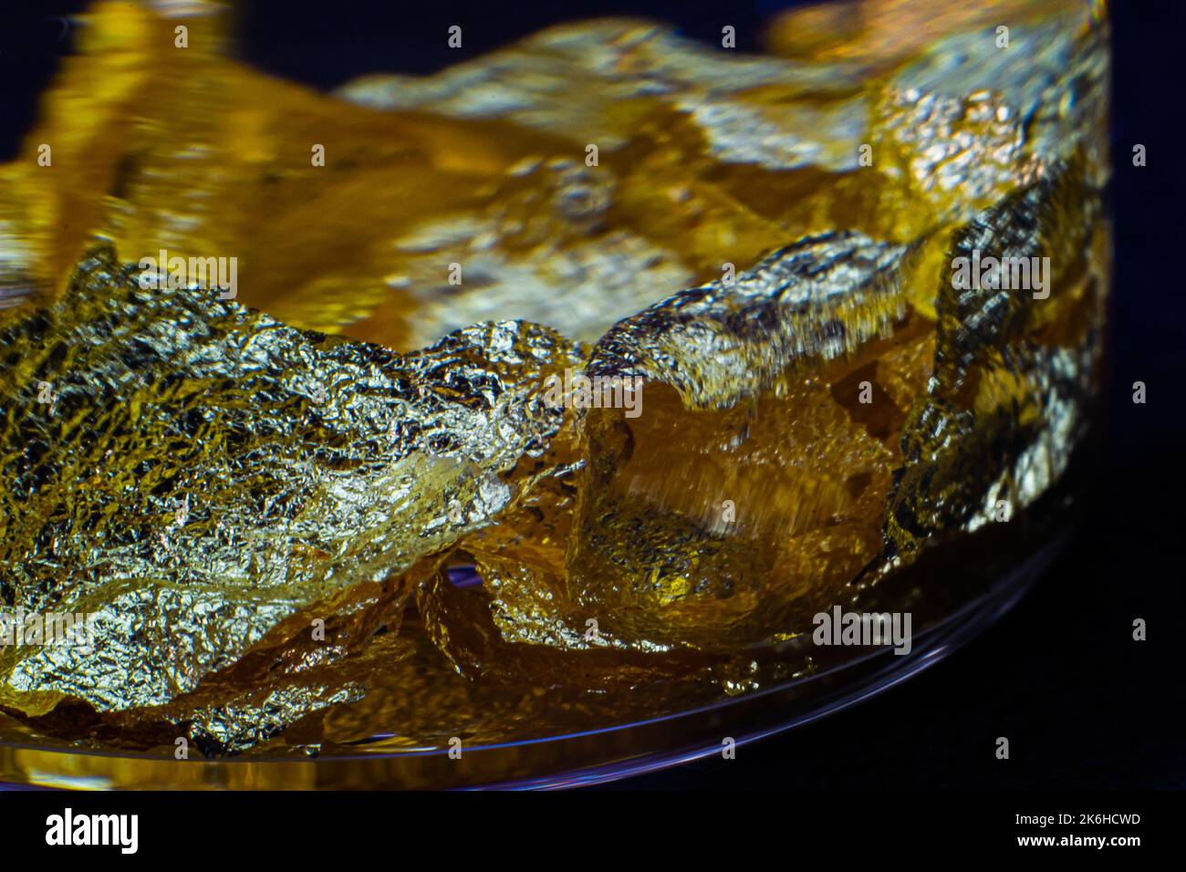 A little glass bottle with a wooden cork on a black surface with 22 ...