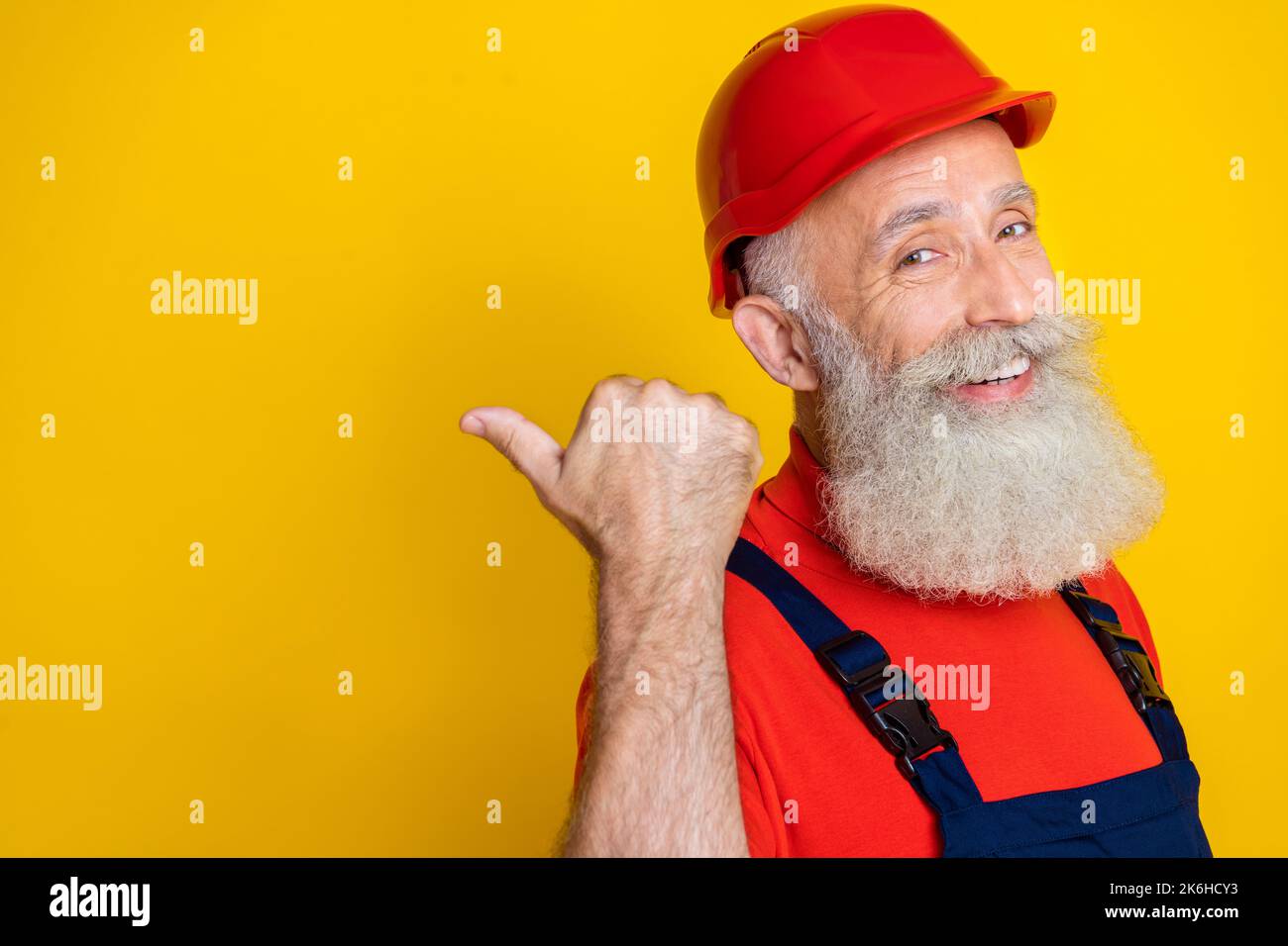 Photo of good mood funny senior guy dressed uniform overall red hardhat ...