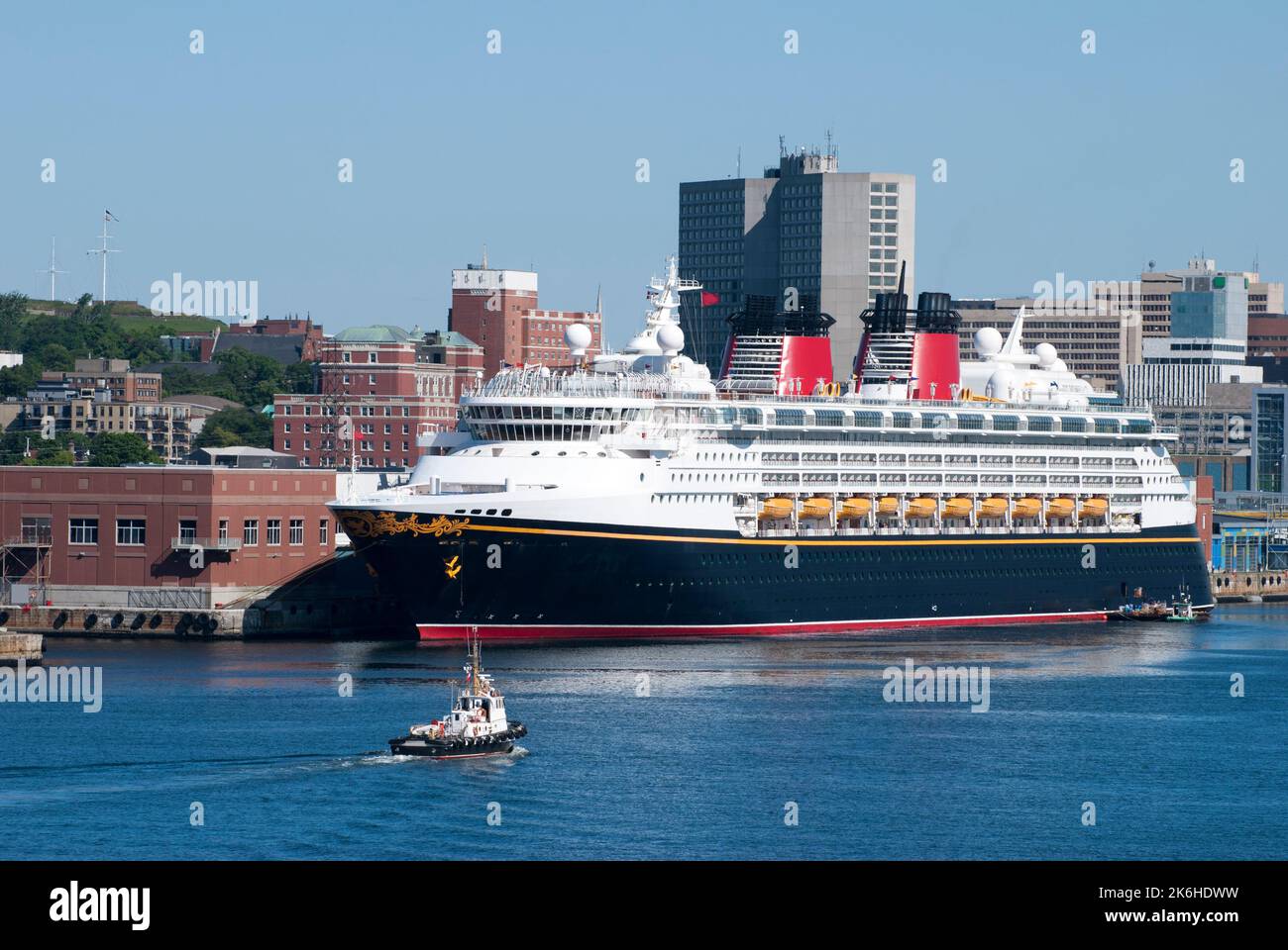 The tugboat passing by a cruise ship moored in Halifax city port (Nova ...