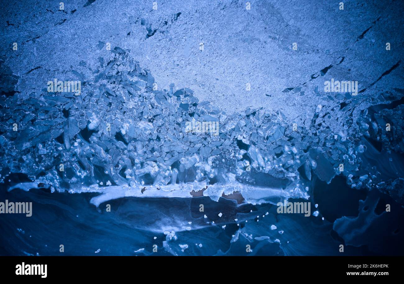 Aerial top view from above of frozen sea glaciers at the beach. Cracked ...