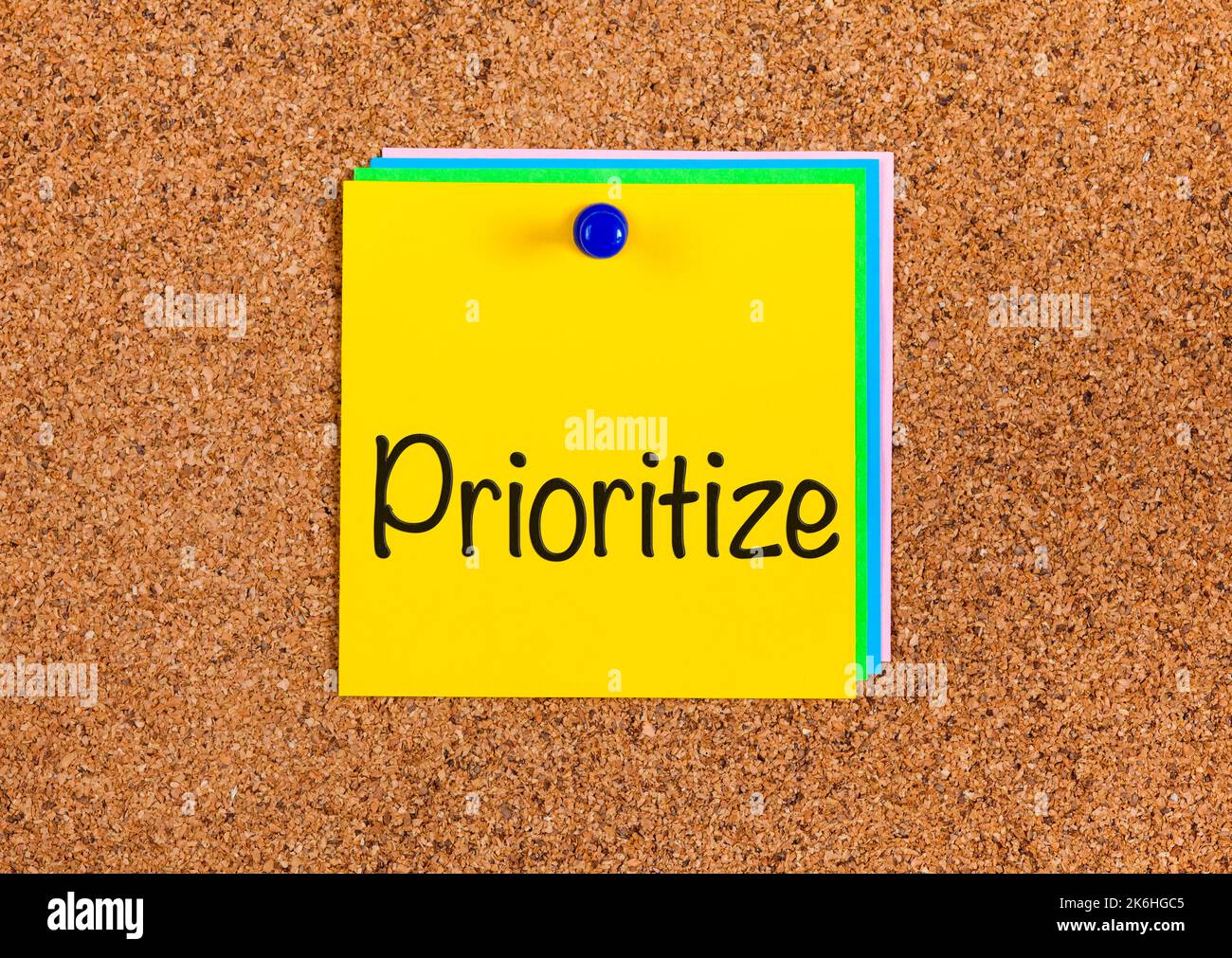 Yellow paper note with word Prioritize on a corkboard Stock Photo - Alamy