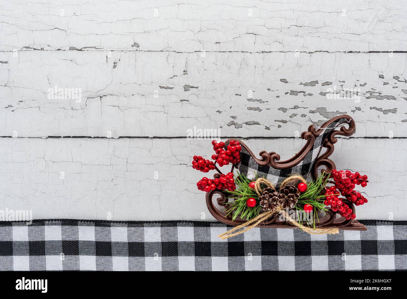 winter holiday theme with black and white gingham ribbon and a sled ...