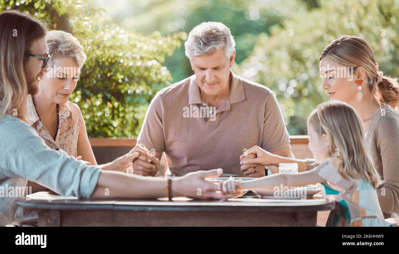 Our faith is our focus. a family sitting together and praying before ...