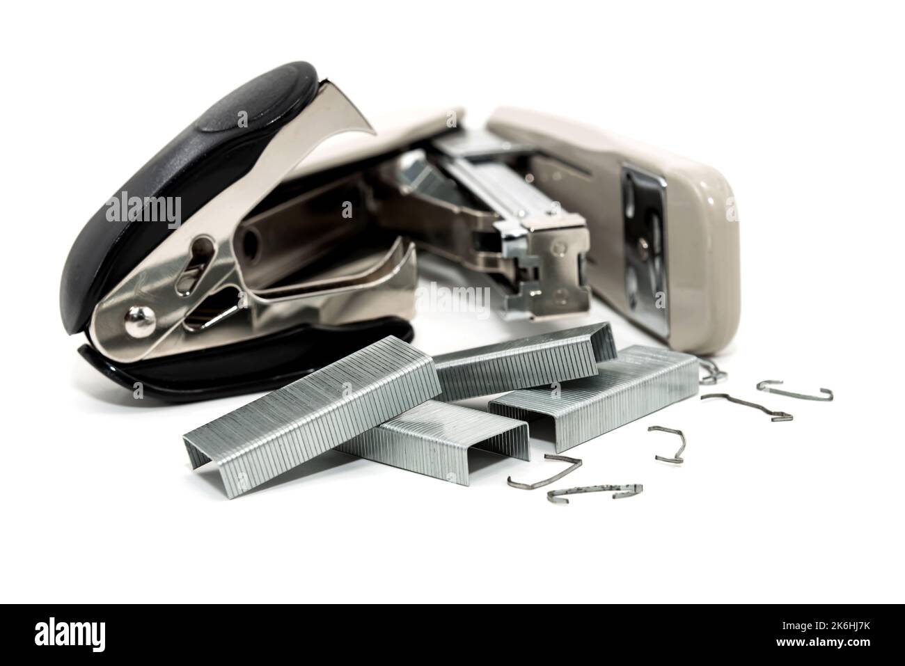 Stapler and anti-stapler with staples on a white background. Office ...