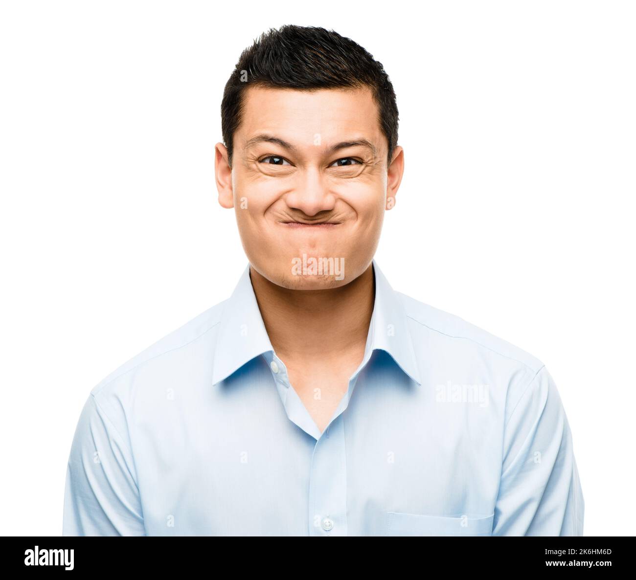 Holding in that burp. a young businessman making a silly face against a ...
