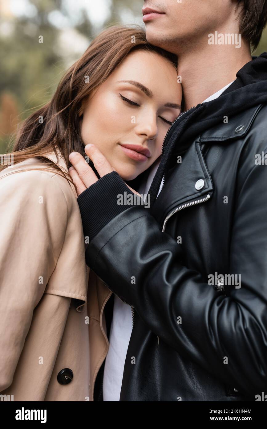 pretty young woman with closed eyes leaning on chest of boyfriend,stock ...