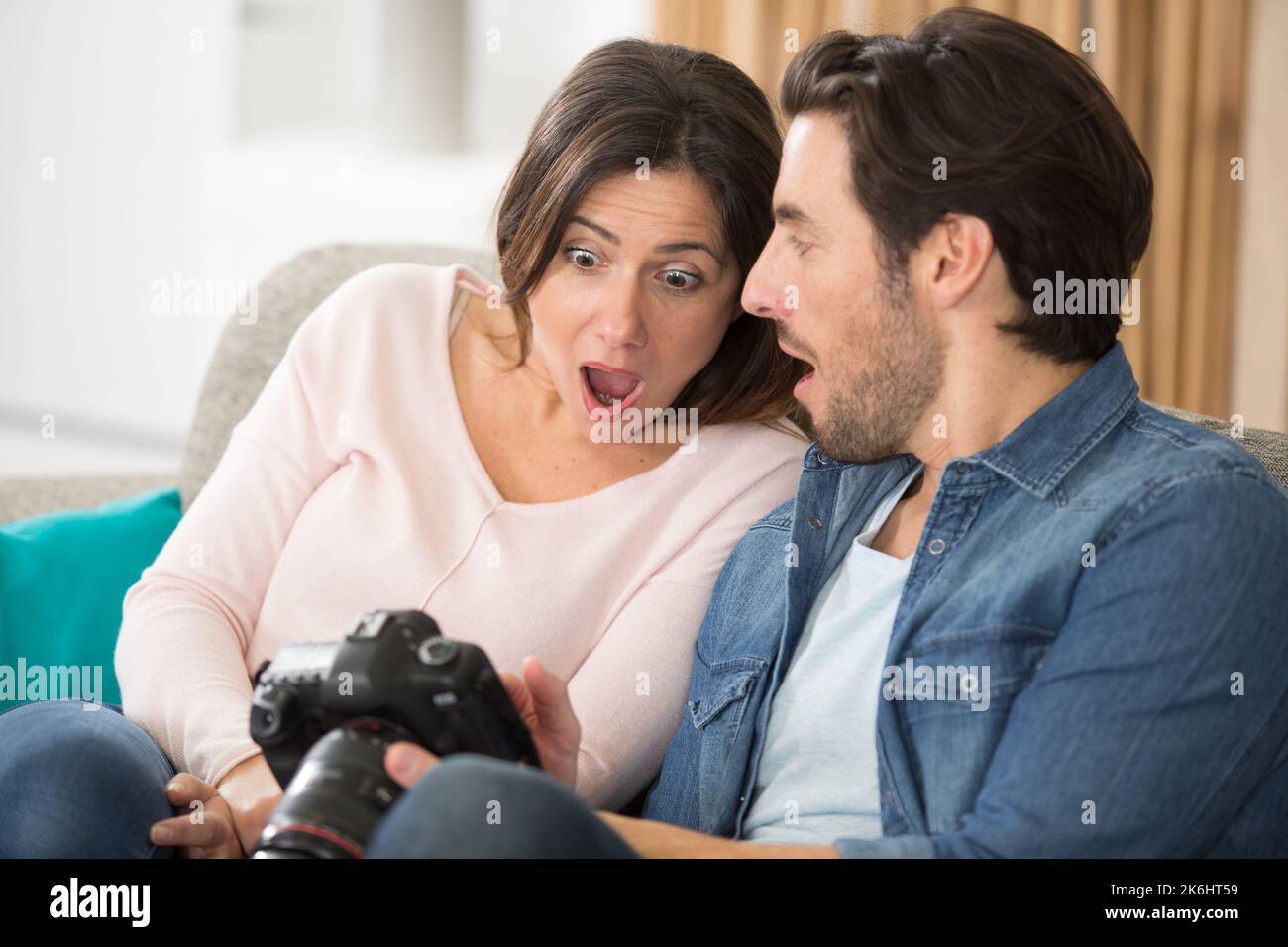 couple shocked by photograph on camera screen Stock Photo - Alamy