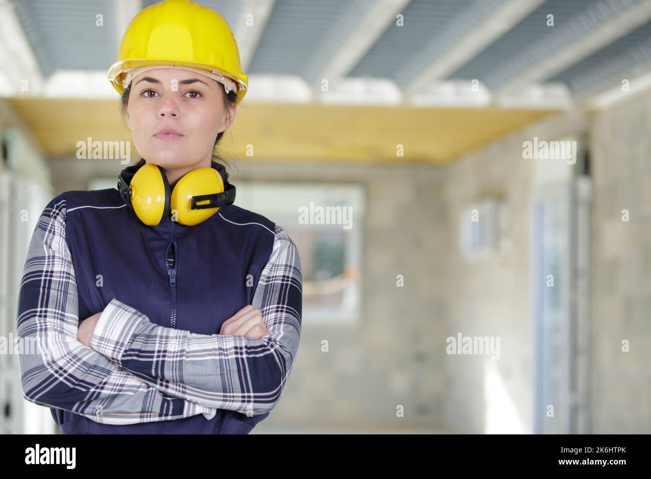 serious female construction worker with her arms crossed Stock Photo ...