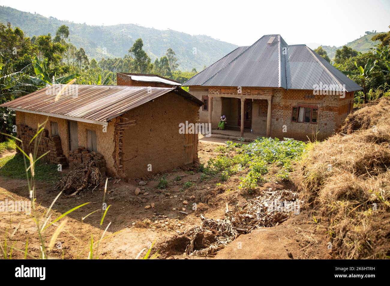 An improved brick house with new metal sheet and small solar panel sits ...