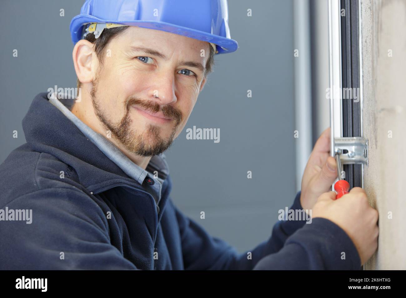professional handyman fixing window handle at home Stock Photo - Alamy
