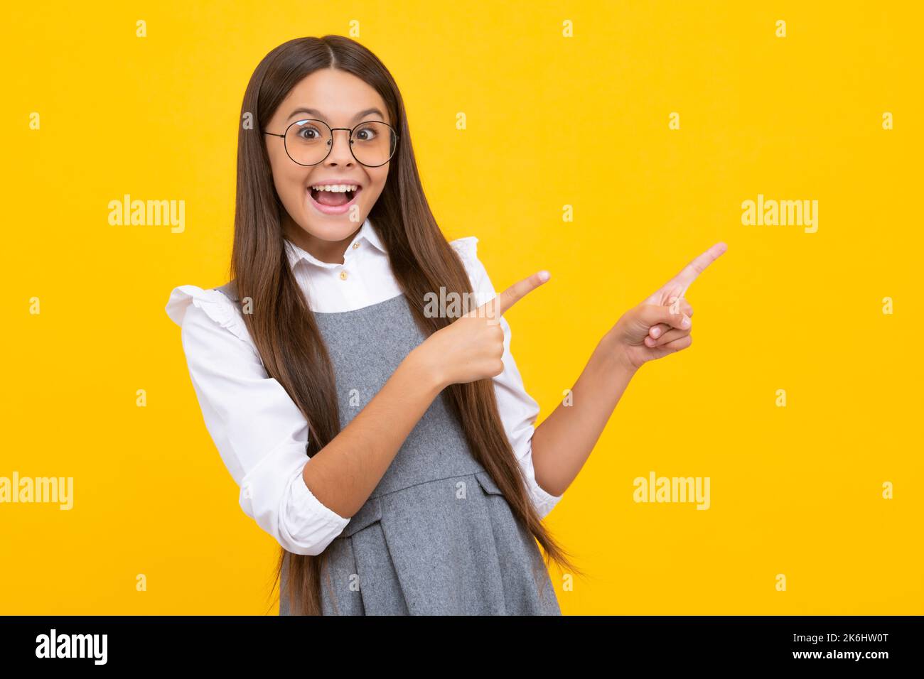 Wow, it's unbelievable. Shocked teenager child pointing aside at copy ...