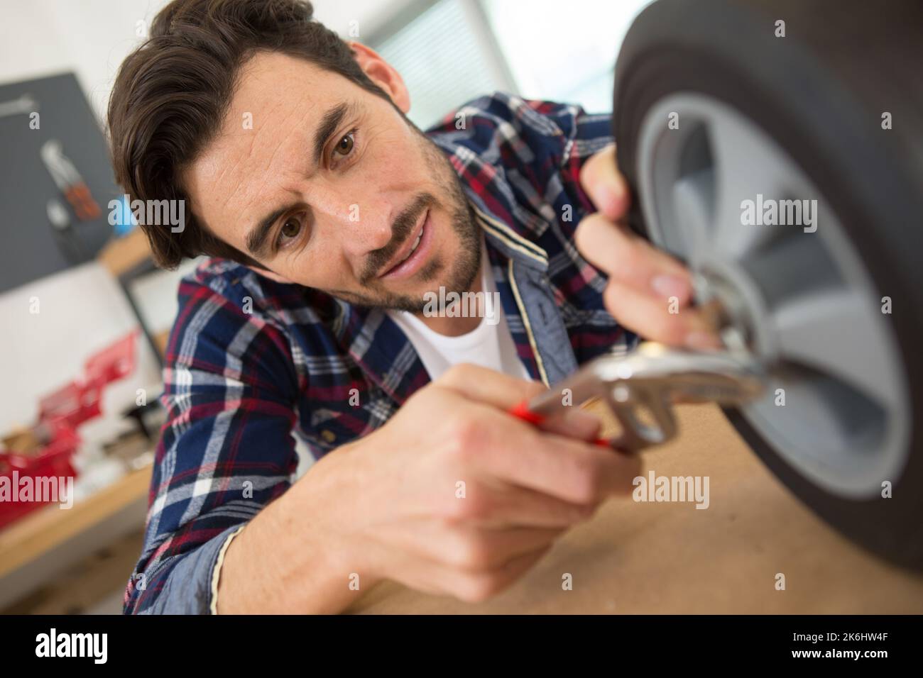 man working on caster wheel Stock Photo - Alamy