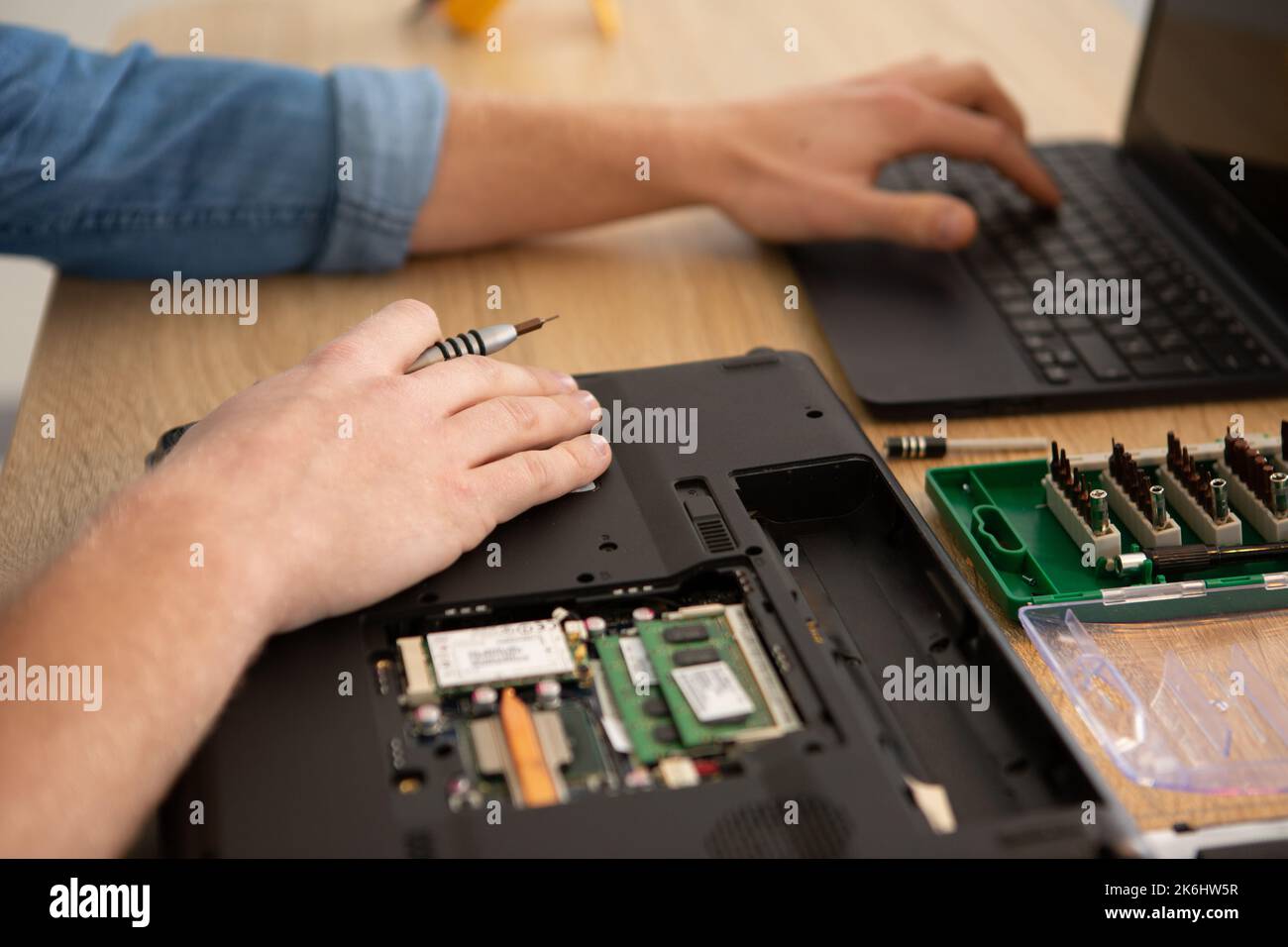 laptop disassembling with screwdriver at repair shop Stock Photo - Alamy