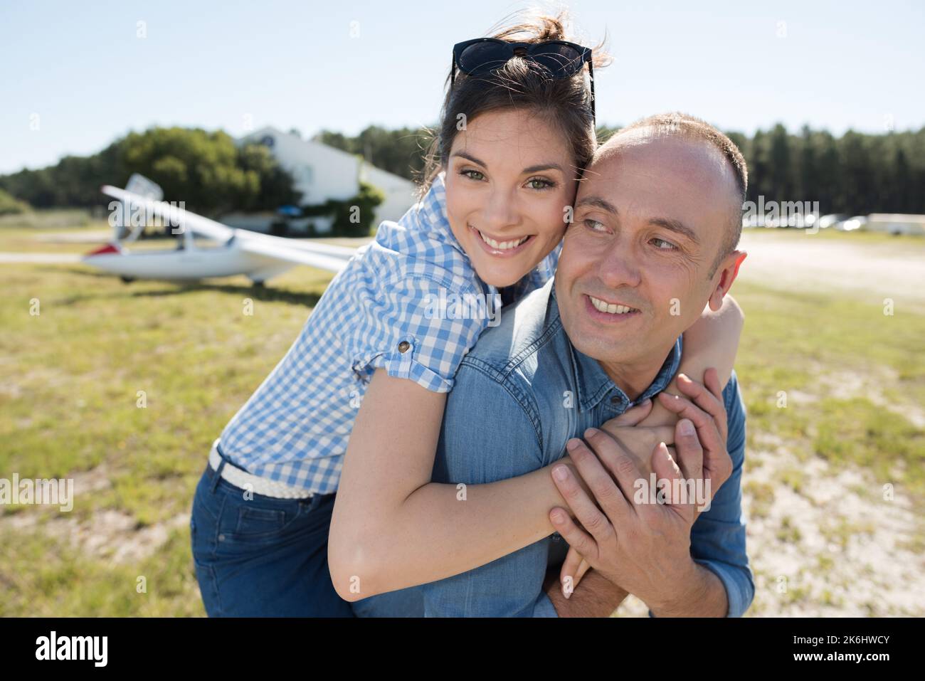 couple standing and hugging near small airplane Stock Photo - Alamy
