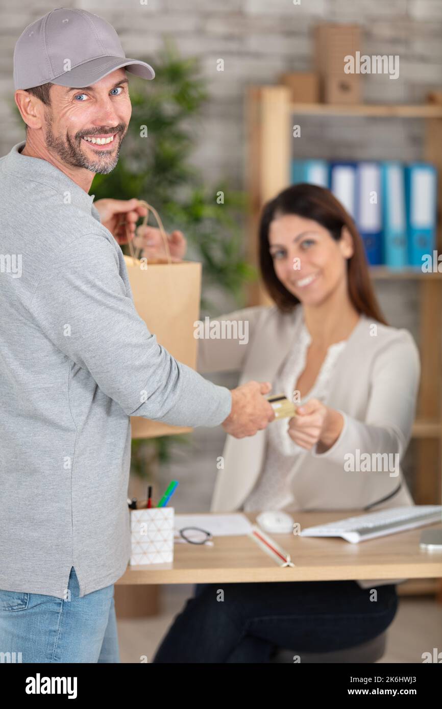Woman receiving order from hi-res stock photography and images - Alamy