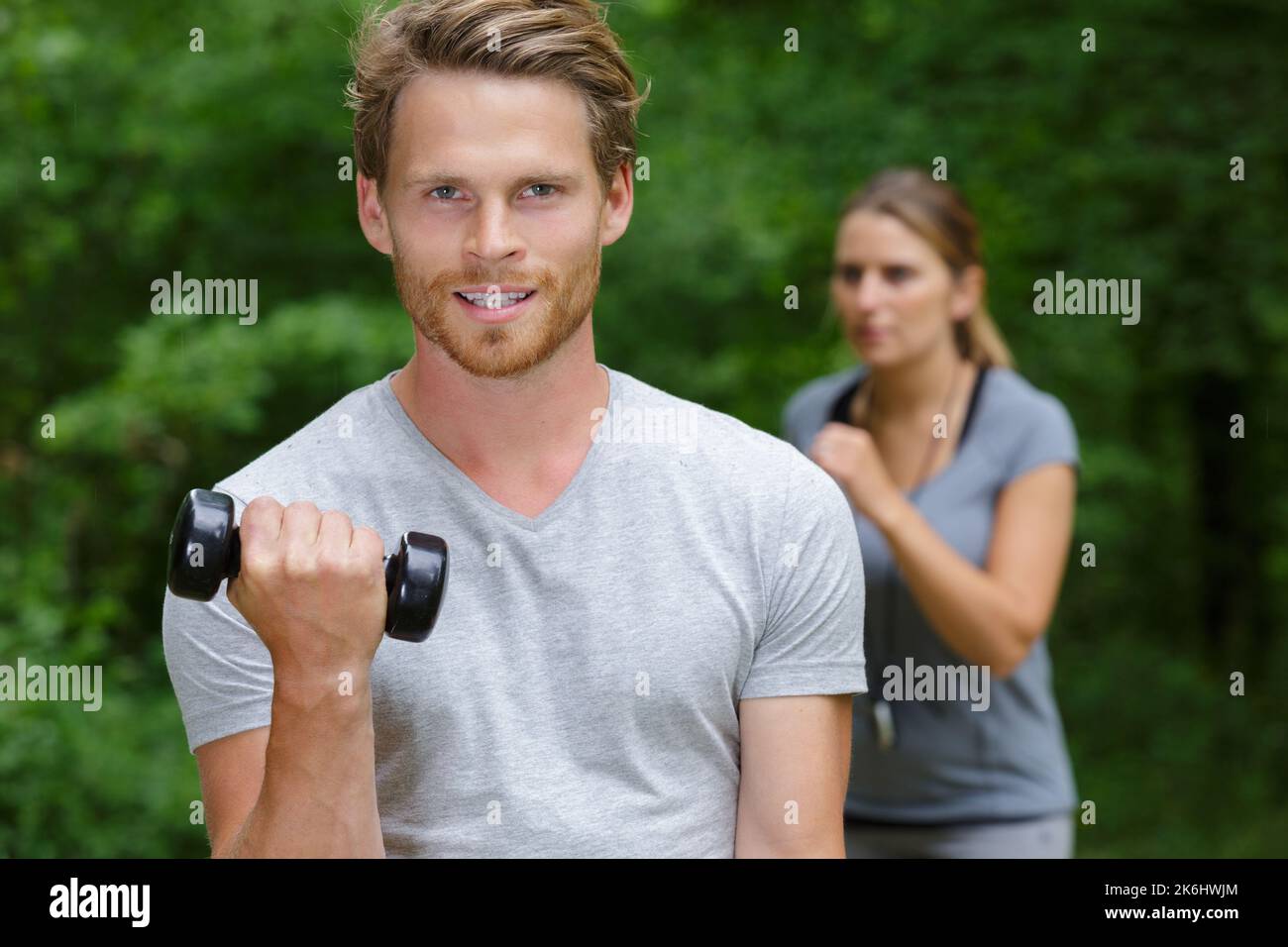 man holding small dumbbell posing outdoor Stock Photo - Alamy