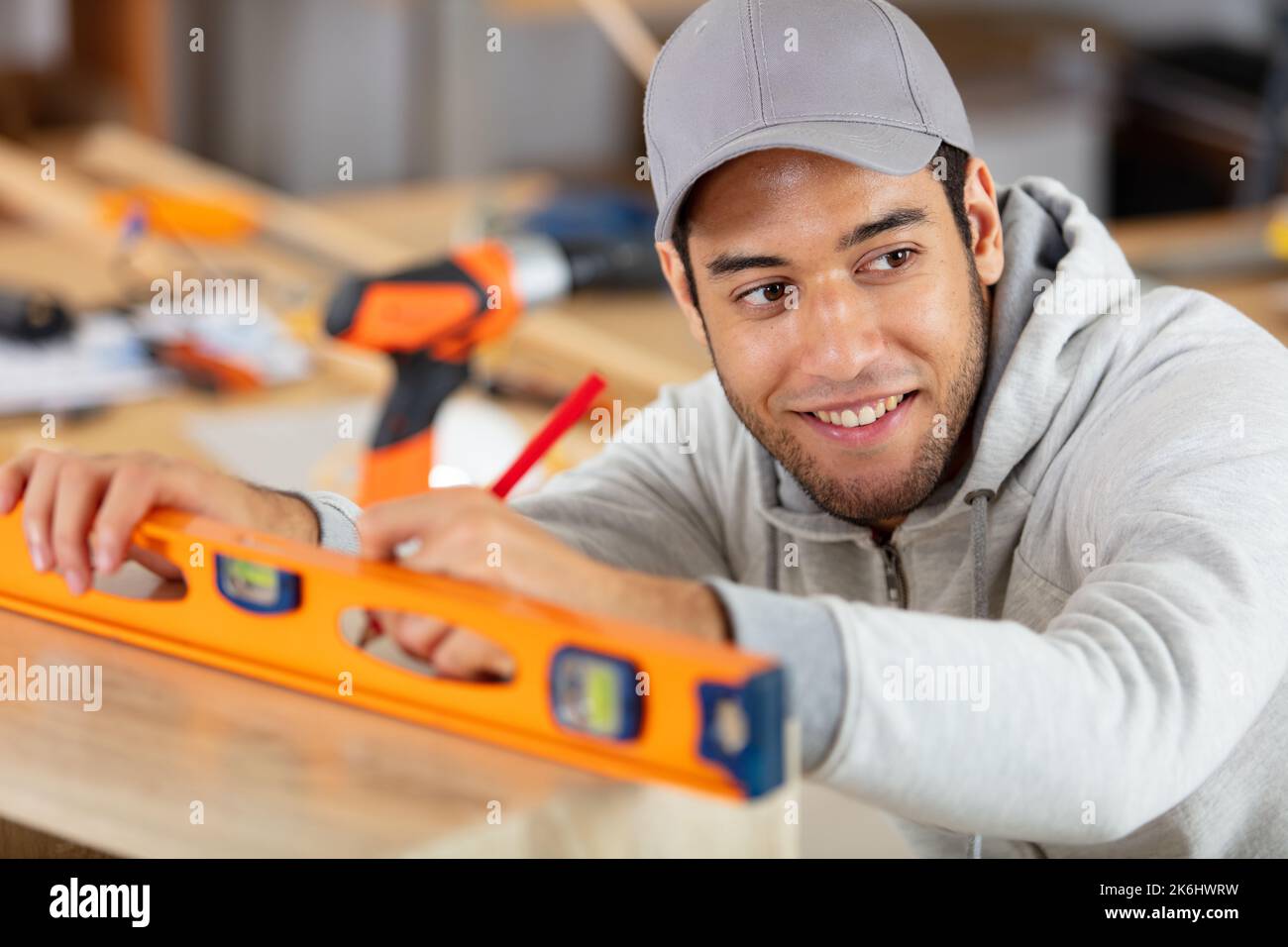 carpenter using at a bubble level Stock Photo - Alamy