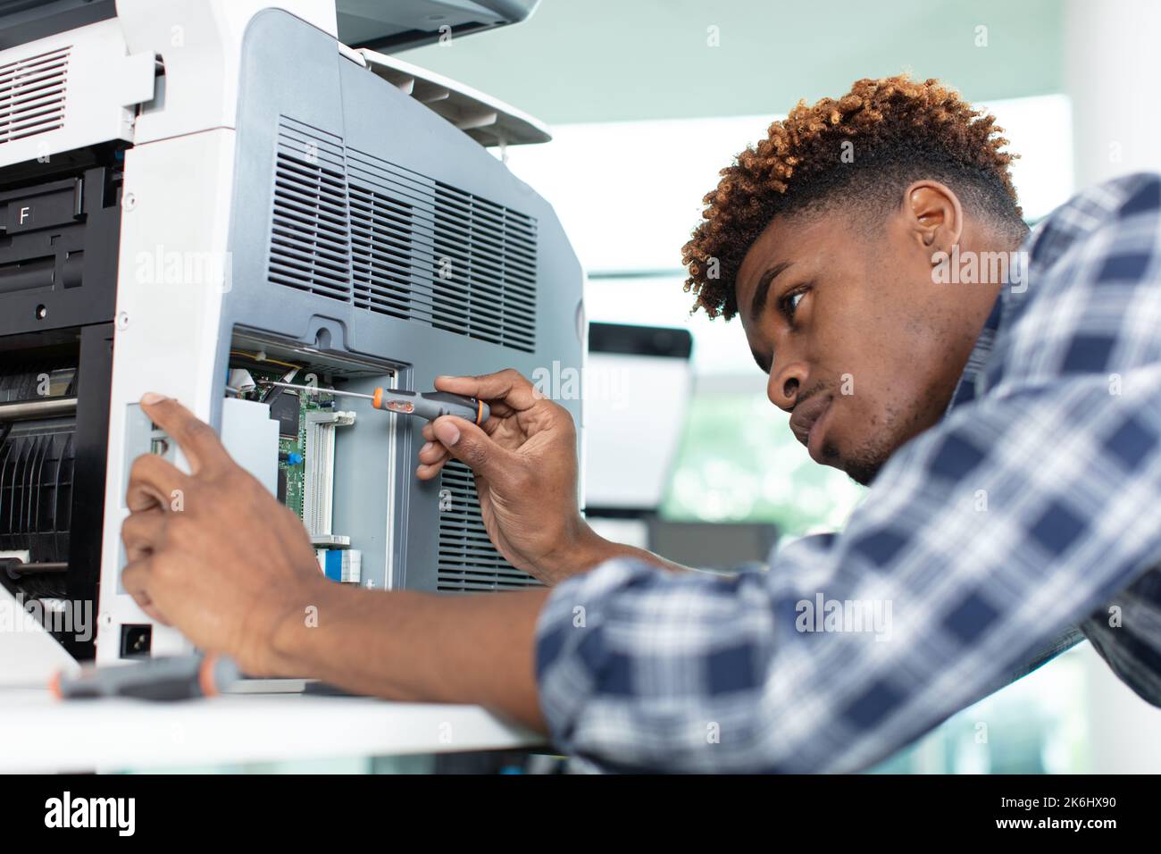 young man fixing a printer Stock Photo - Alamy