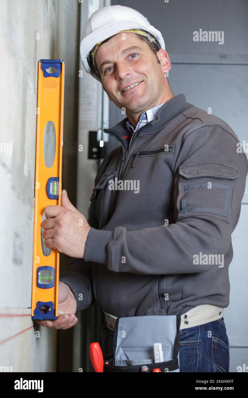 happy worker inspecting a window sill using a builders level Stock ...