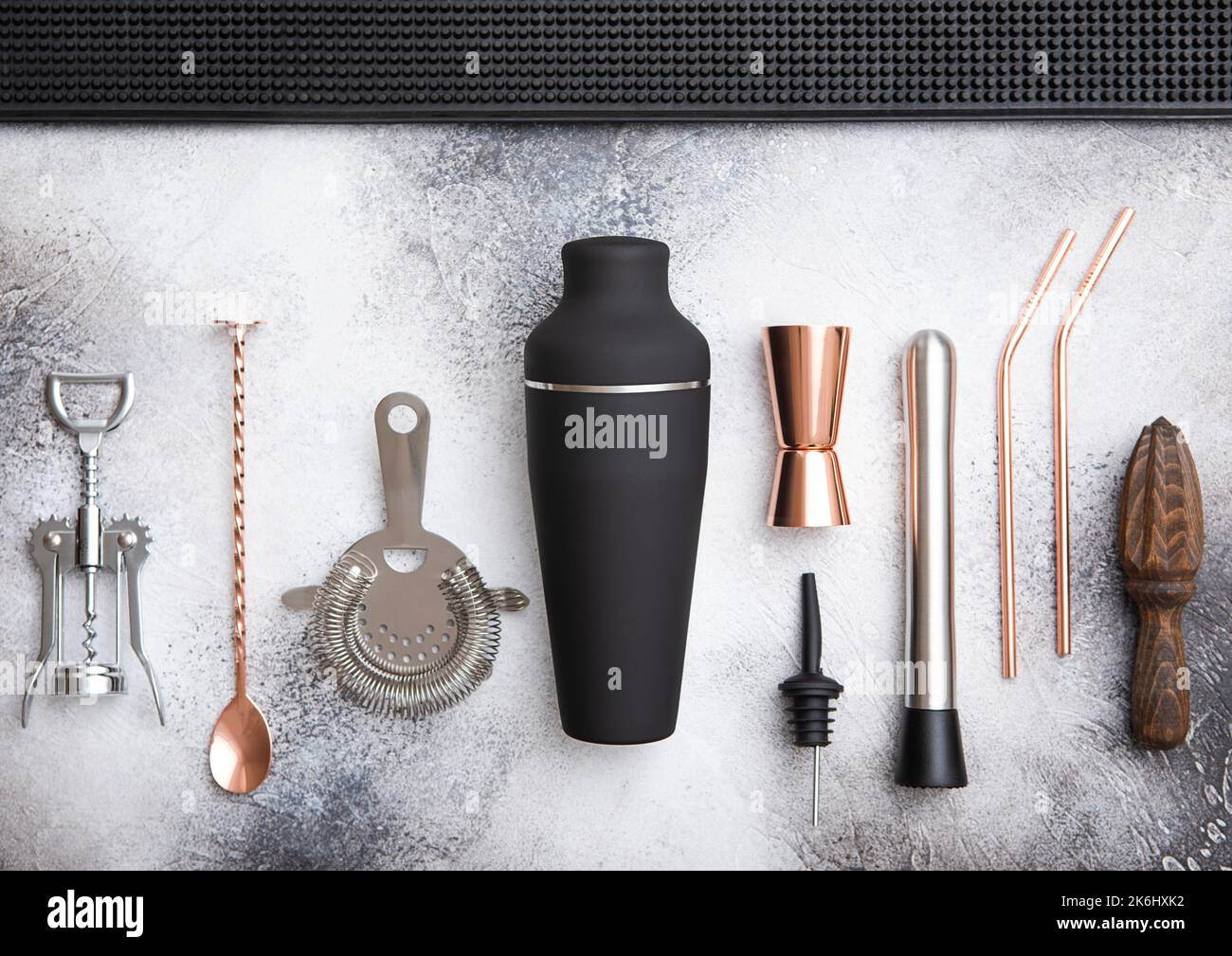 Various cocktail utensils.Copper jigger,straw and spoon with black ...