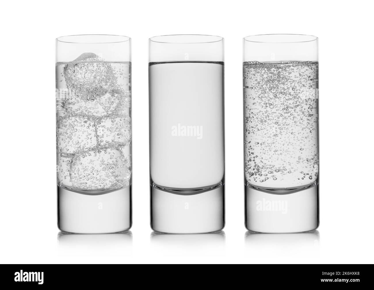 Highball glasses with sparkling and still mineral water drink on white. With ice cubes and ...