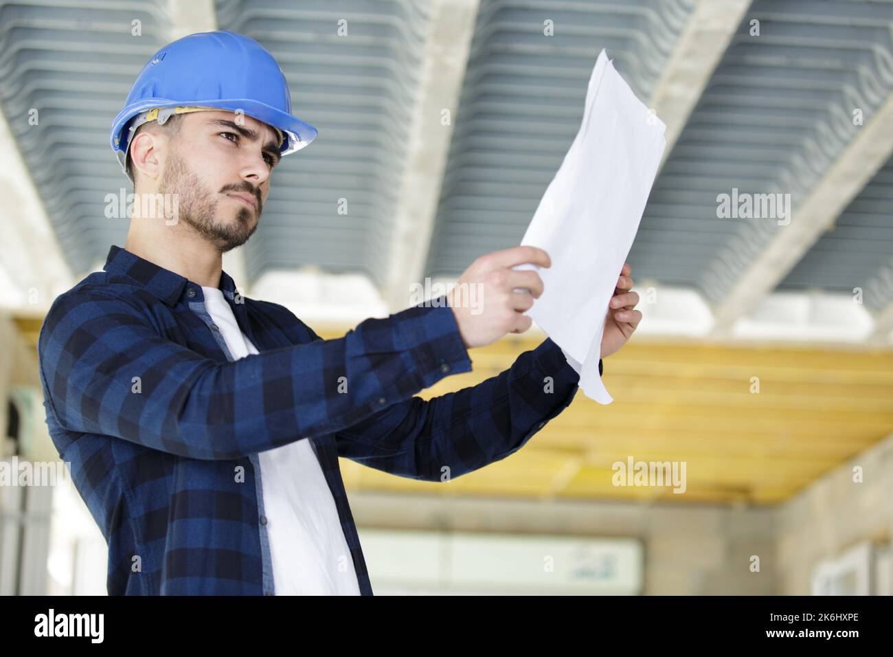 a handsome engineer checking paperwork Stock Photo - Alamy