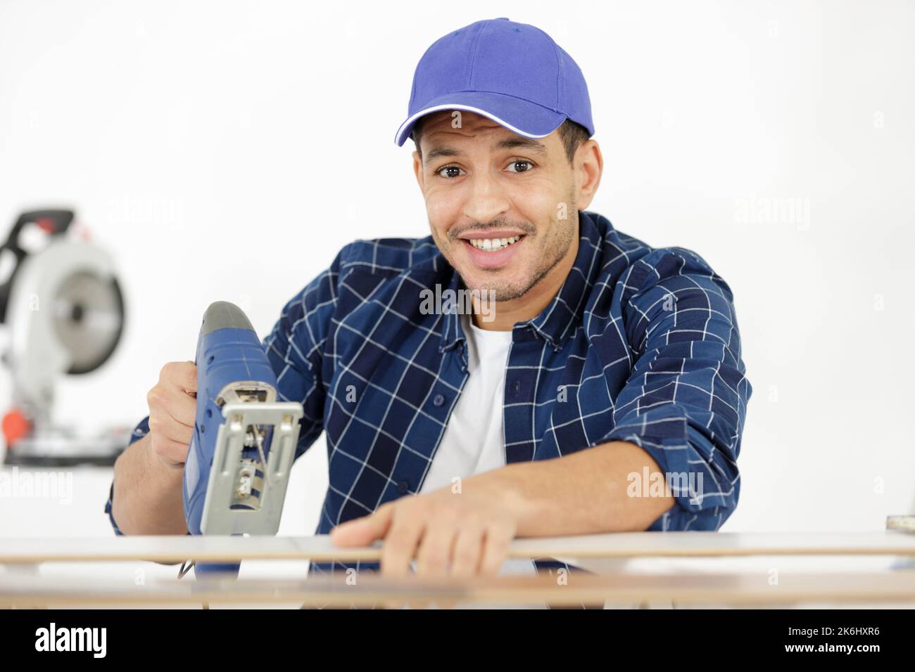 man cutting wood with a machine Stock Photo - Alamy