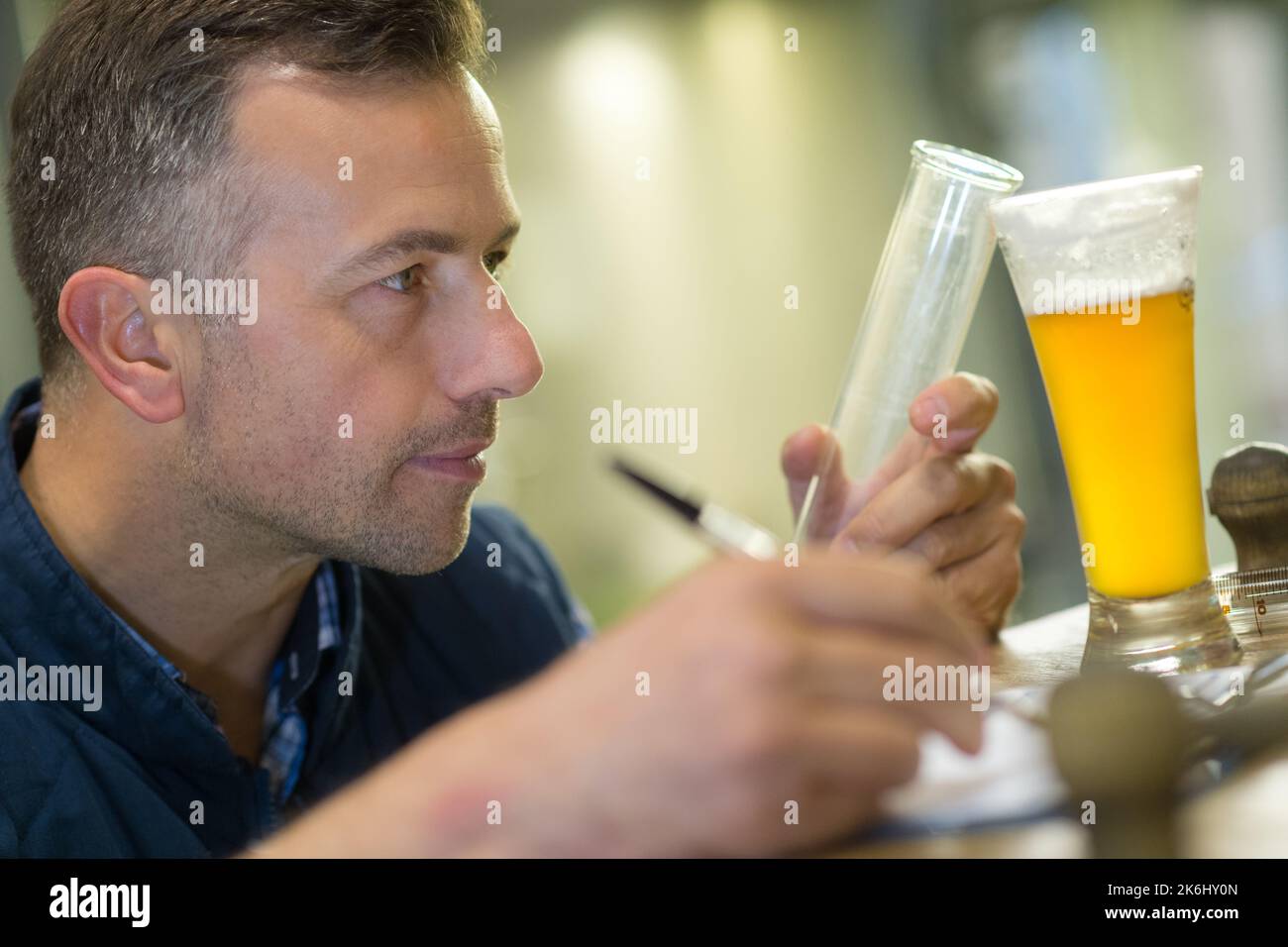 focused brewer testing his beer Stock Photo - Alamy